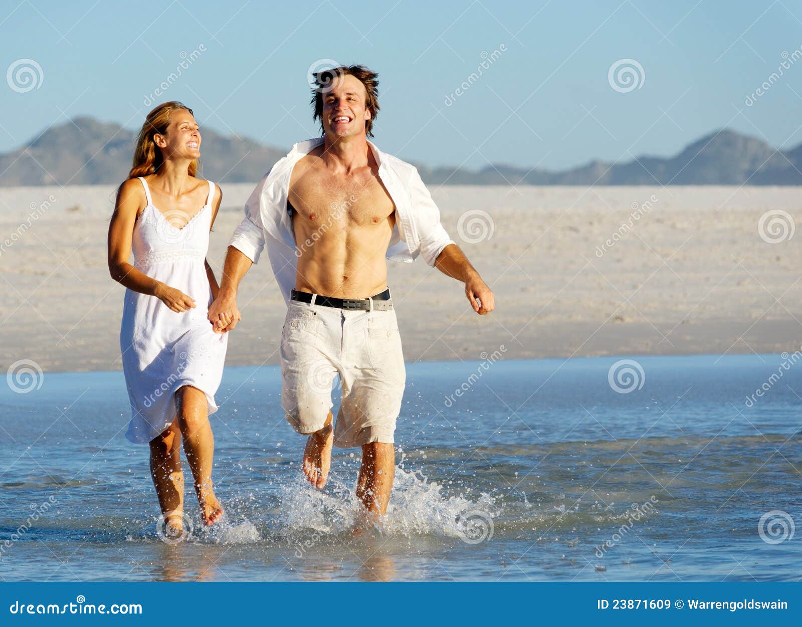 Beach run splash couple stock image. Image of attractive - 23871609