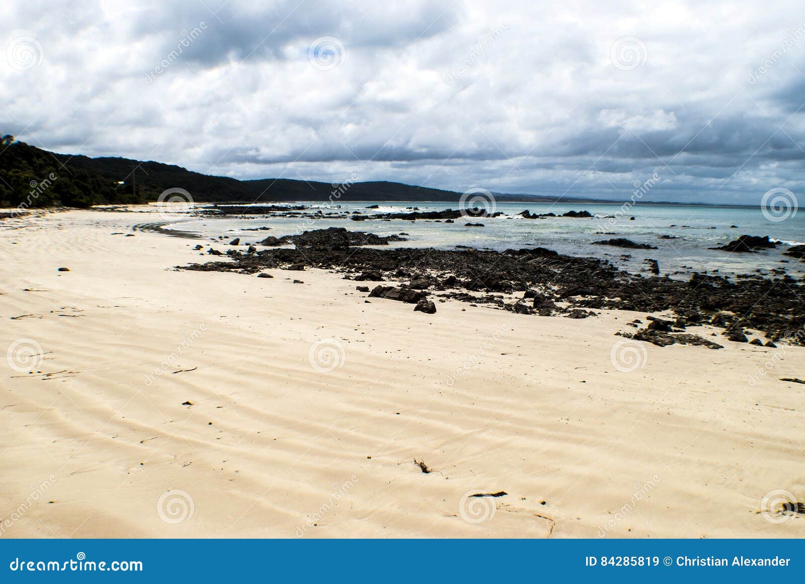 Beach with Sand, Ocean and an Overcast Sky Stock Image - Image of ...