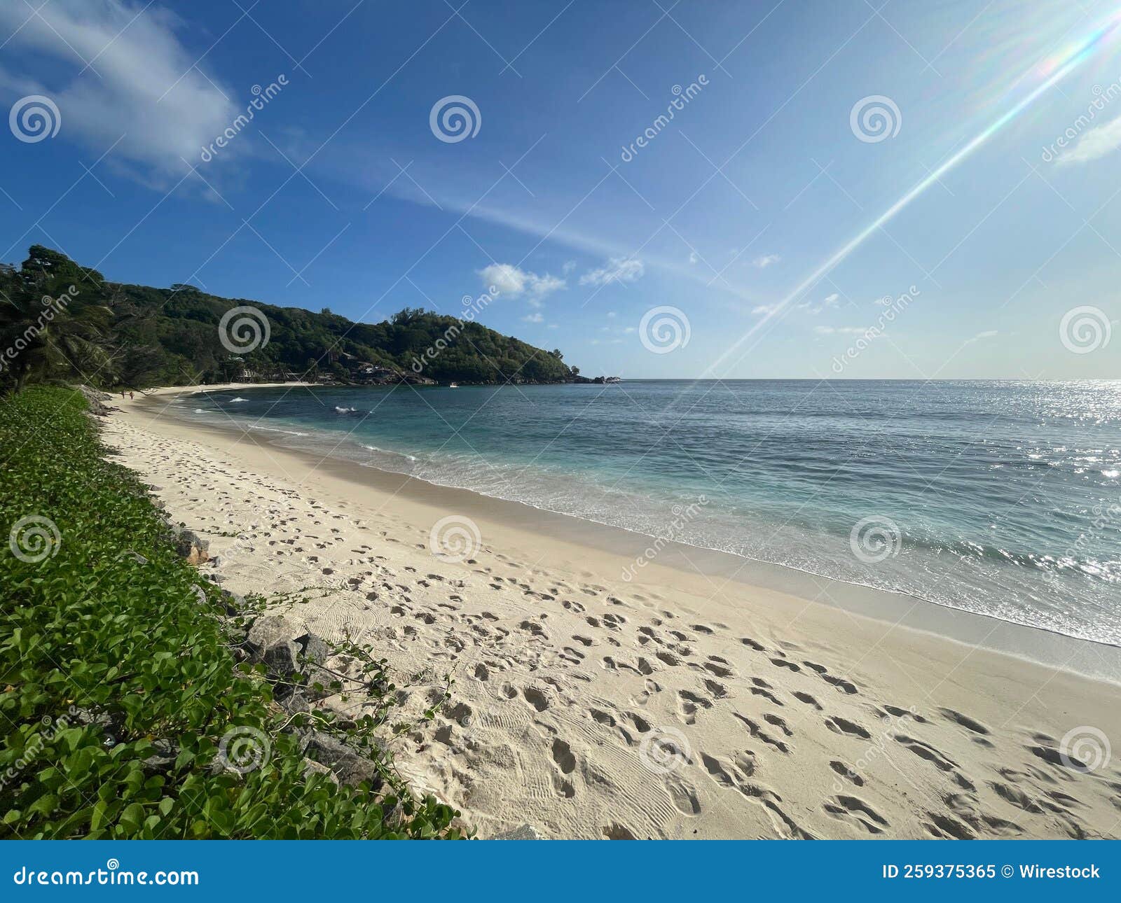 Beach Sand in the Seychelles Covered with Footprints and Shallow Waves ...