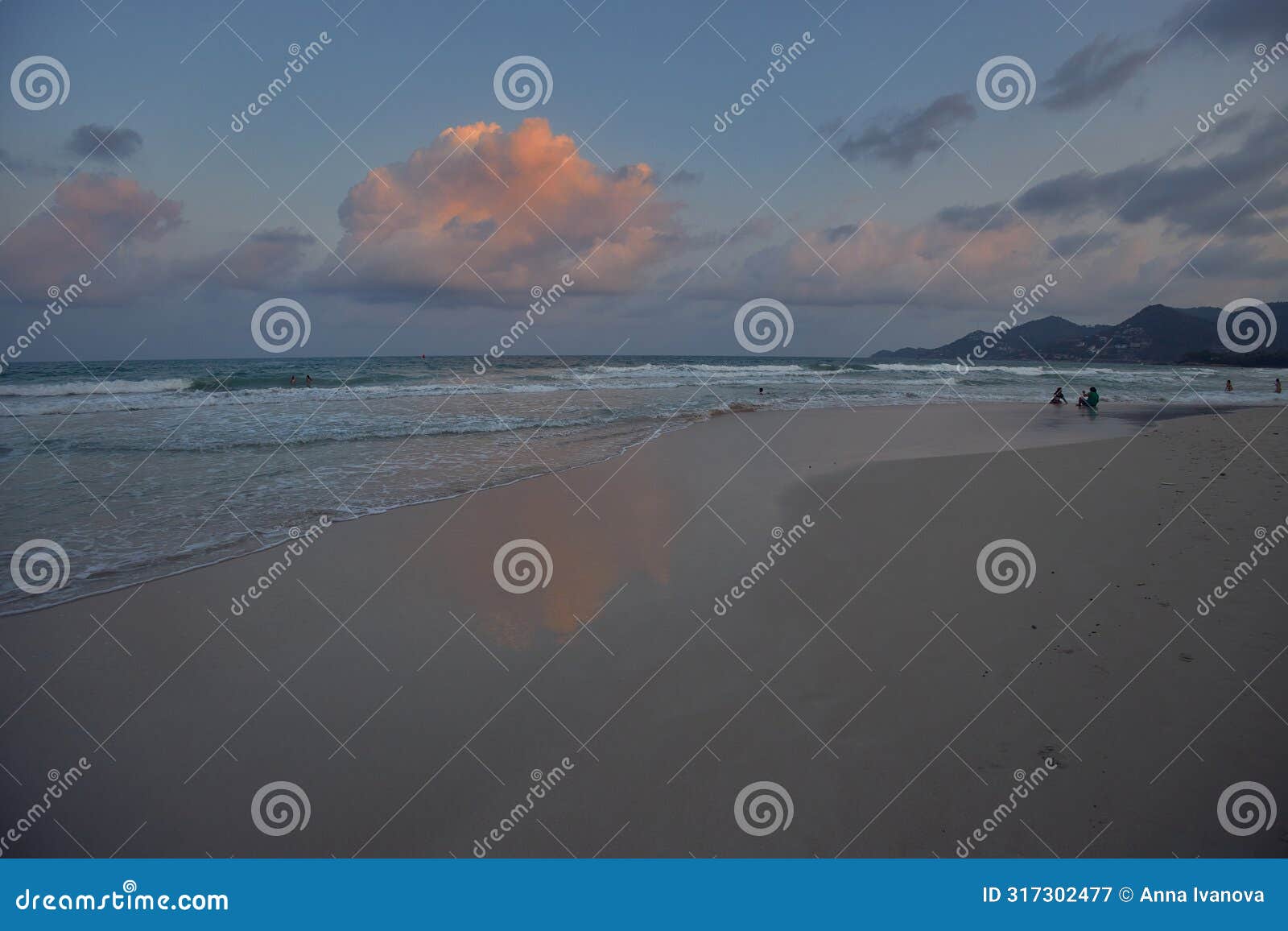 Beach Scene at Dusk with a Vibrant Cloud Reflection on Wet Sand and ...