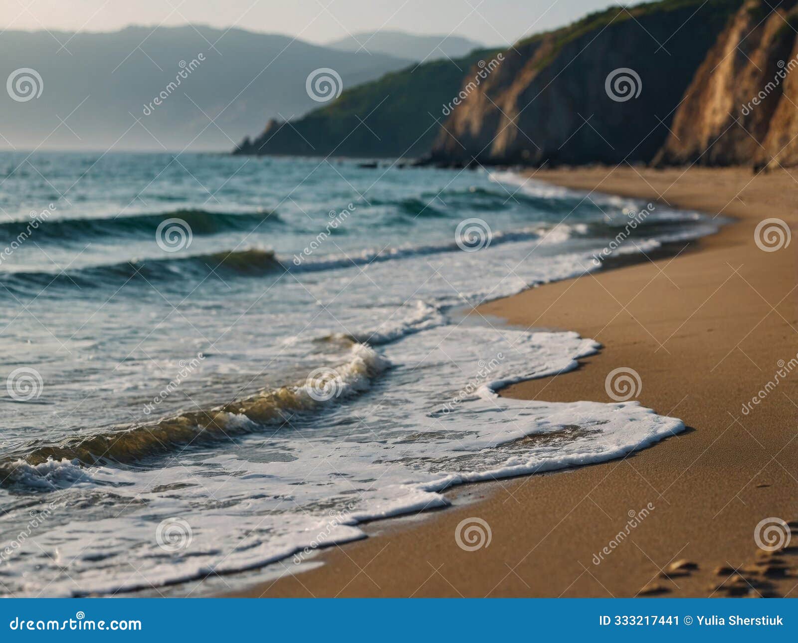 A Beach Scene with Incoming Waves at the Shoreline and a Cliff Beyond ...
