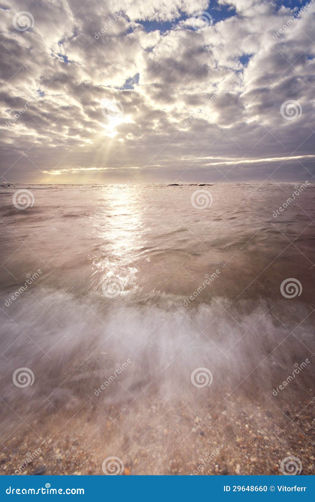 Beach Scene with Sun Beams in the Horizon Stock Photo - Image of sand ...