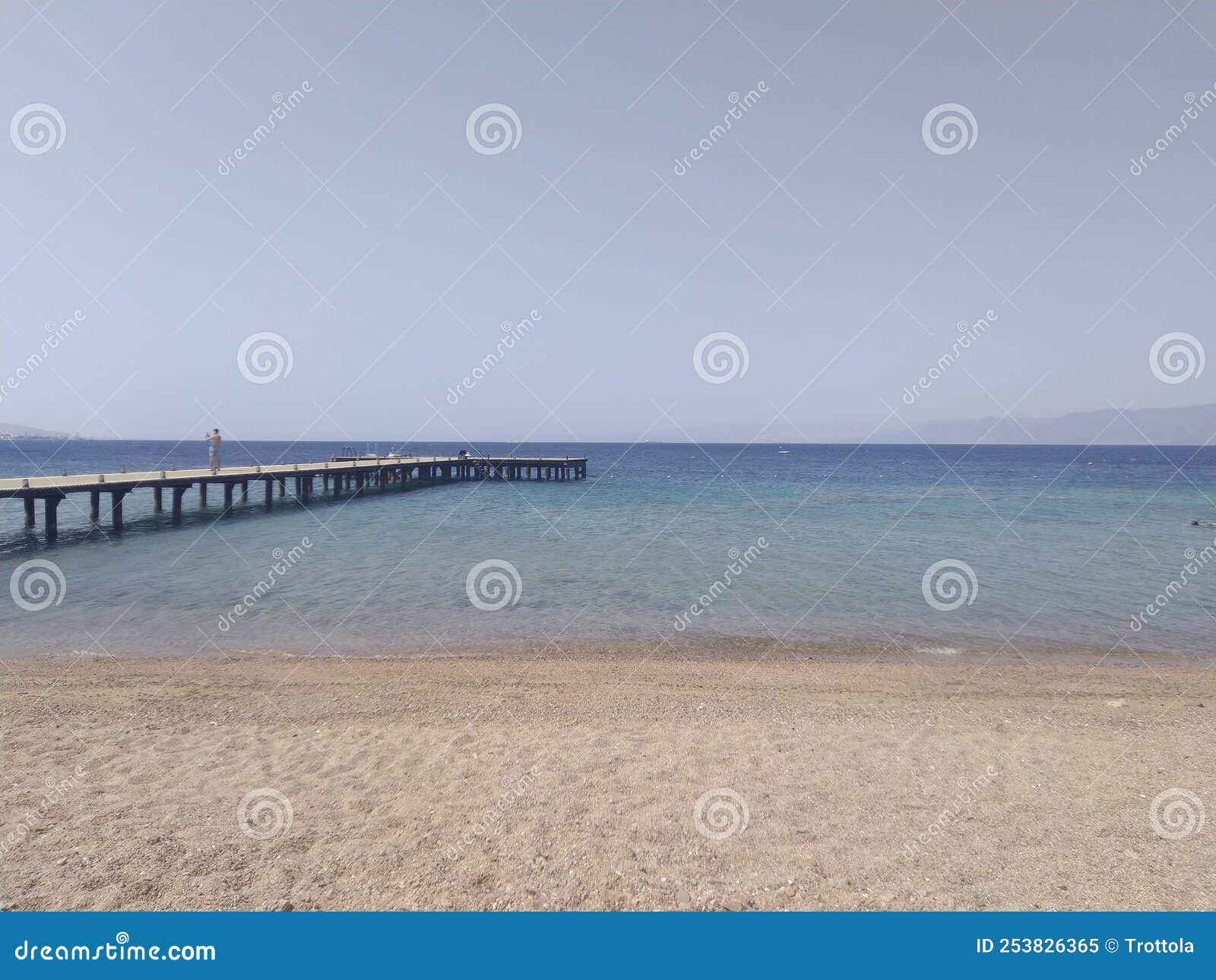 Beach with small wood pier stock image. Image of breakwater - 253826365