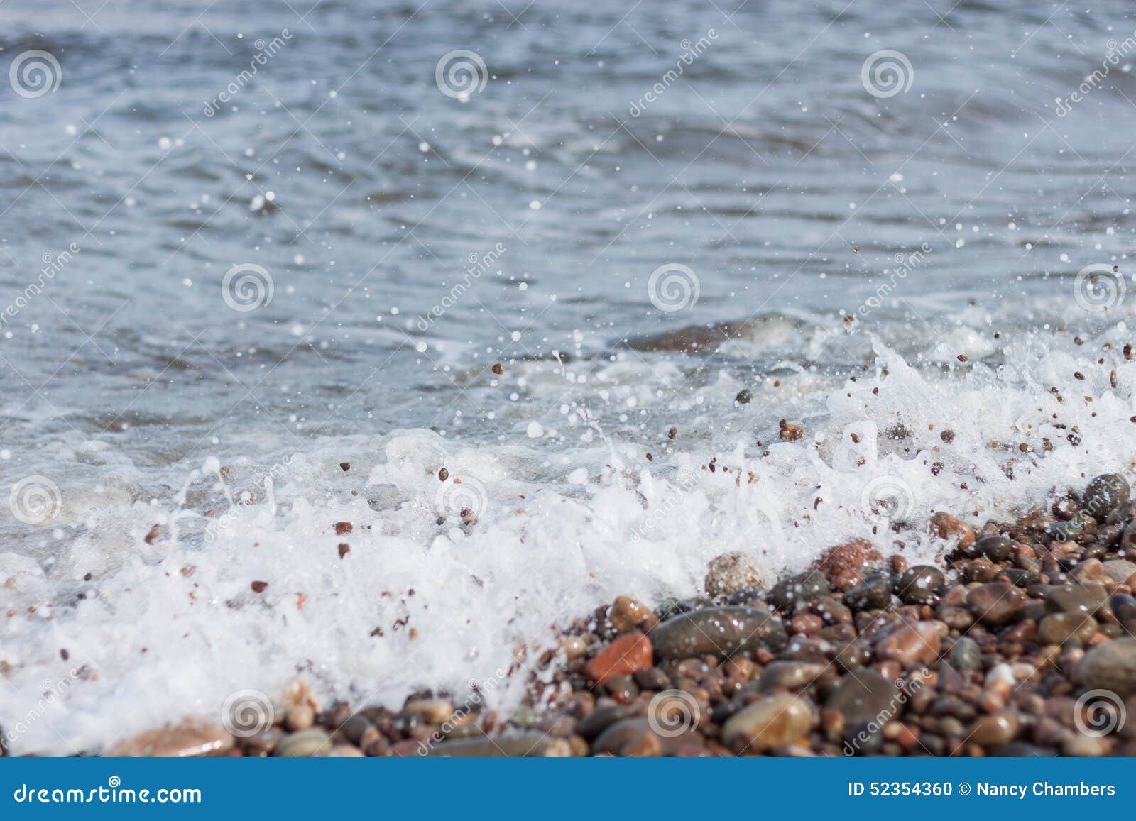 Beach stones in the surf stock photo. Image of waves - 52354360