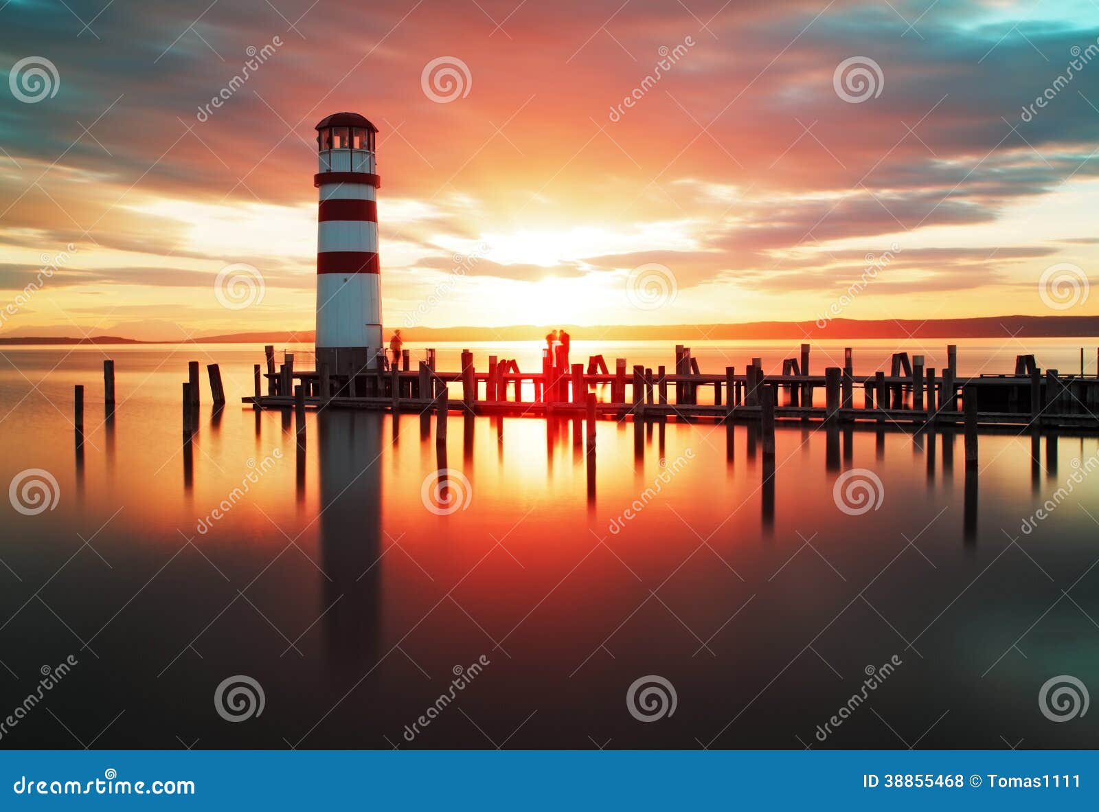 Beach Sunrise with Lighthouse Stock Photo - Image of clouds, coast ...