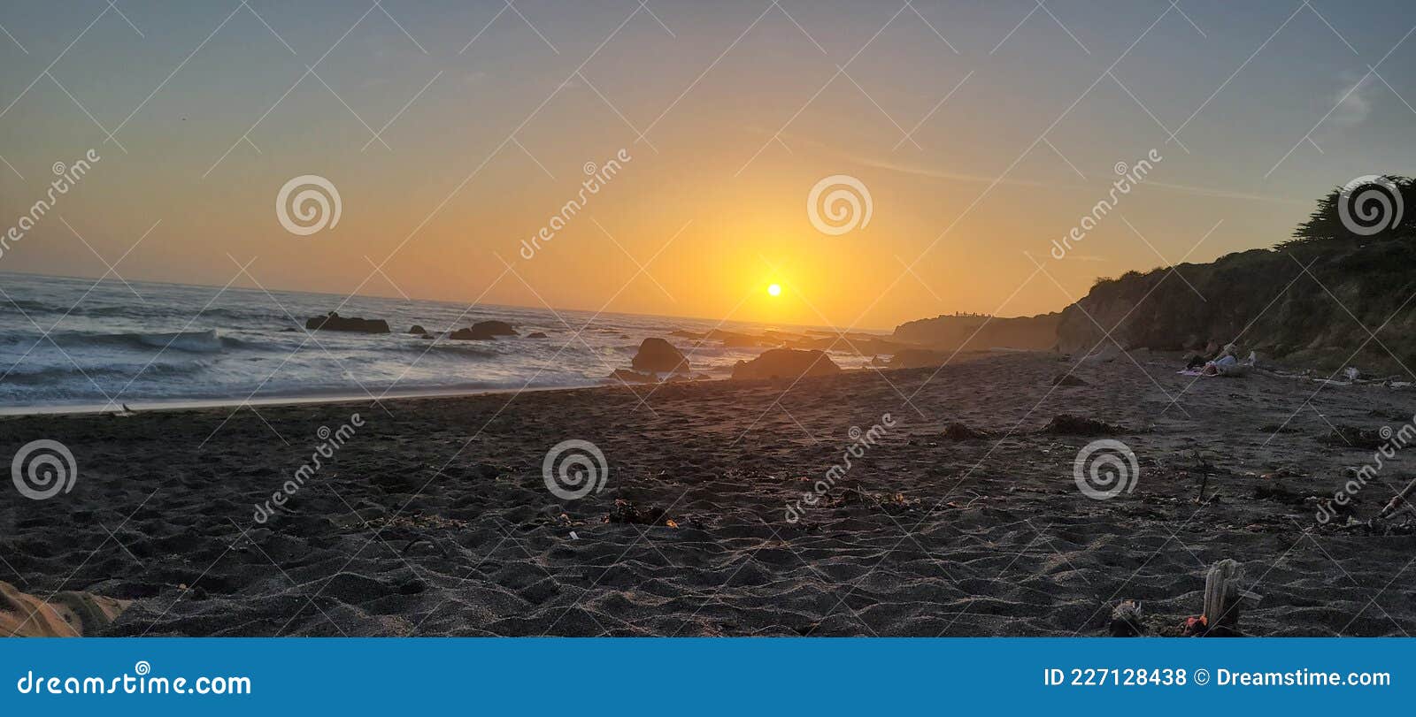 Beach sunset on cambrea stock photo. Image of sunlight - 227128438