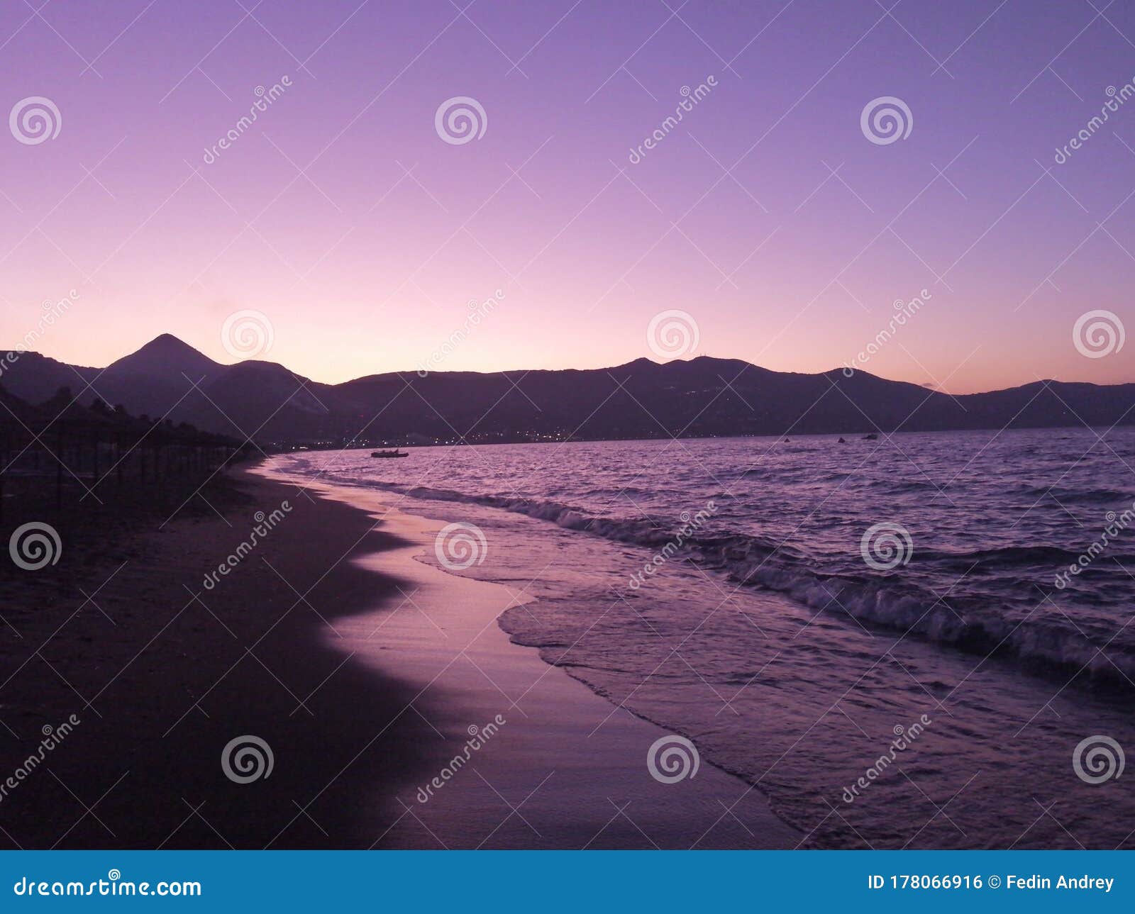 Beach at Sunset Against the Background of Mountains Stock Photo - Image ...