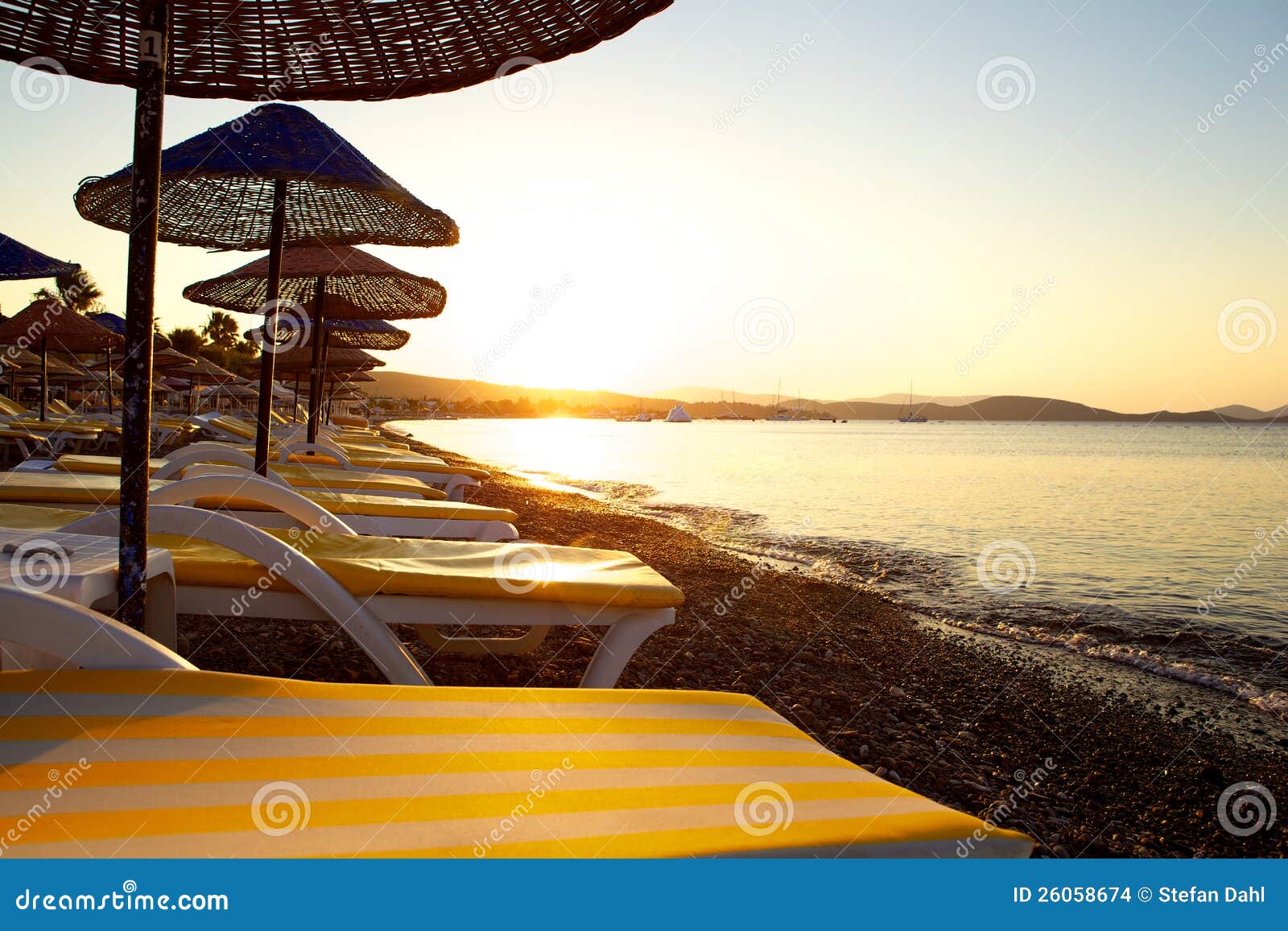 Beach with Sunset and Sun Beds Stock Photo - Image of setting ...