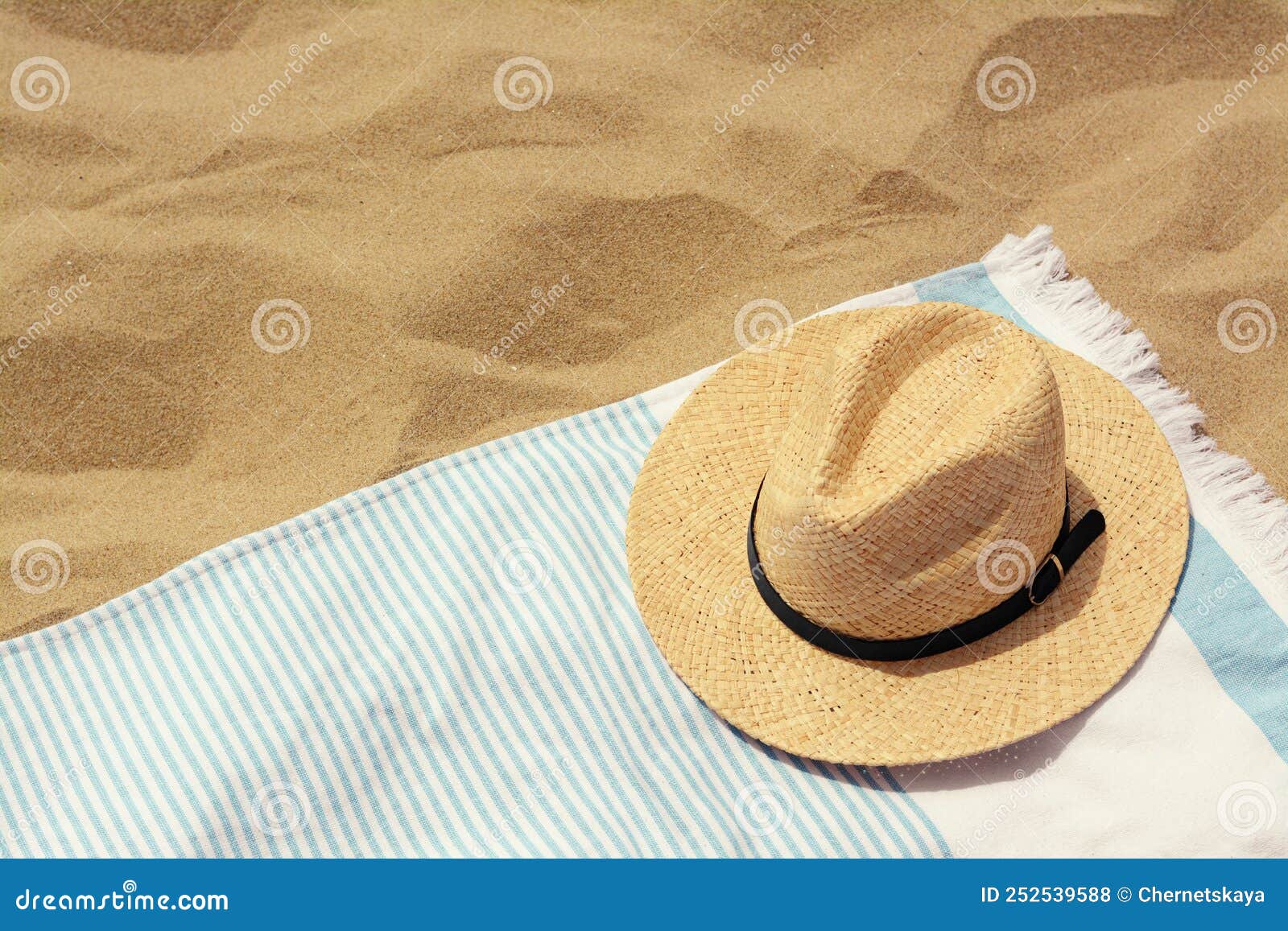Beach Towel with Straw Hat on Sand. Space for Text Stock Photo - Image ...