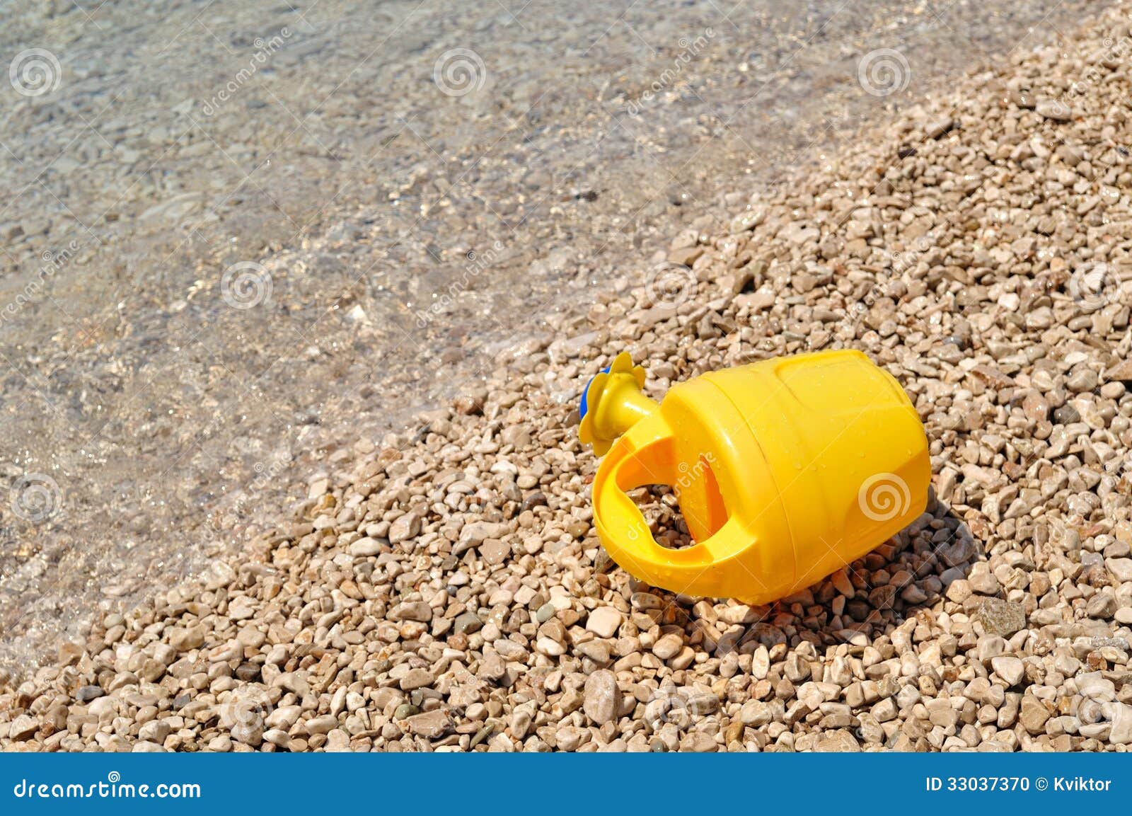 Beach Toys - Yellow Watering Can on the Beach Stock Photo - Image of ...