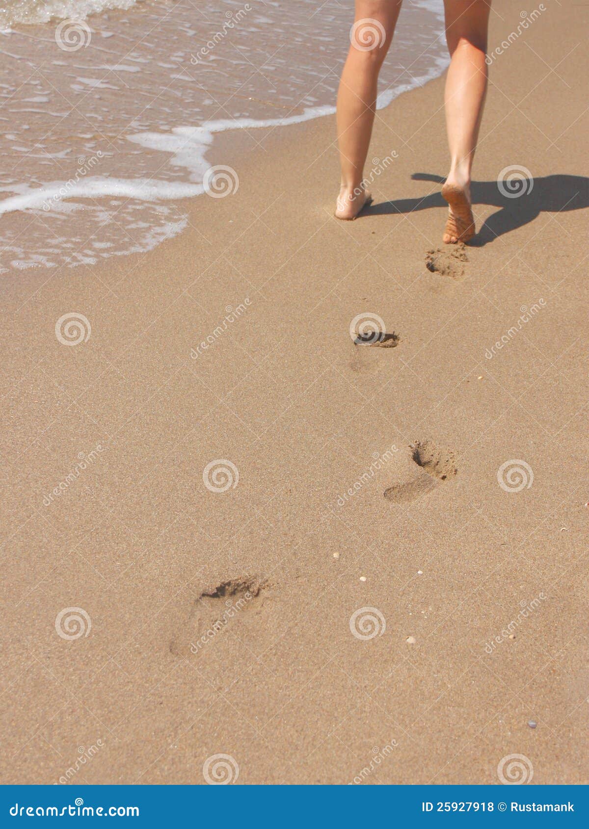 Beach walk with footprints stock photo. Image of water - 25927918