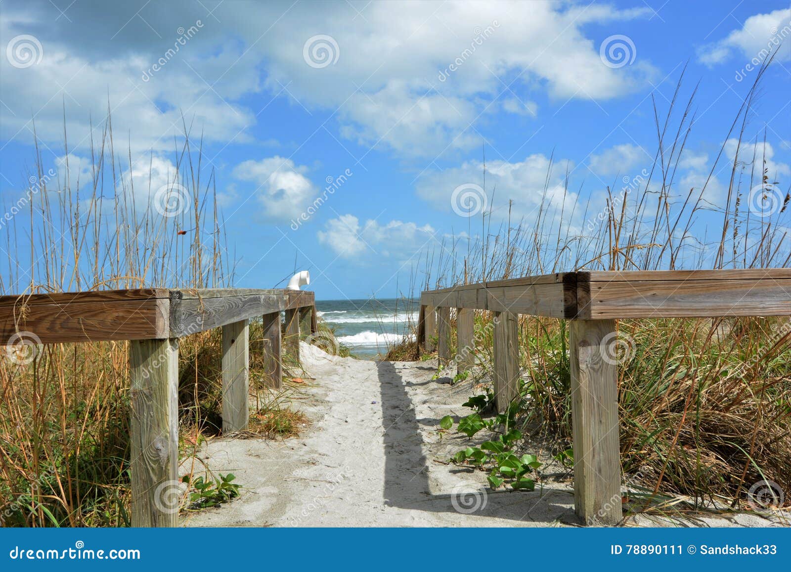 Beach Walkway Under Clouds stock image. Image of high - 78890111