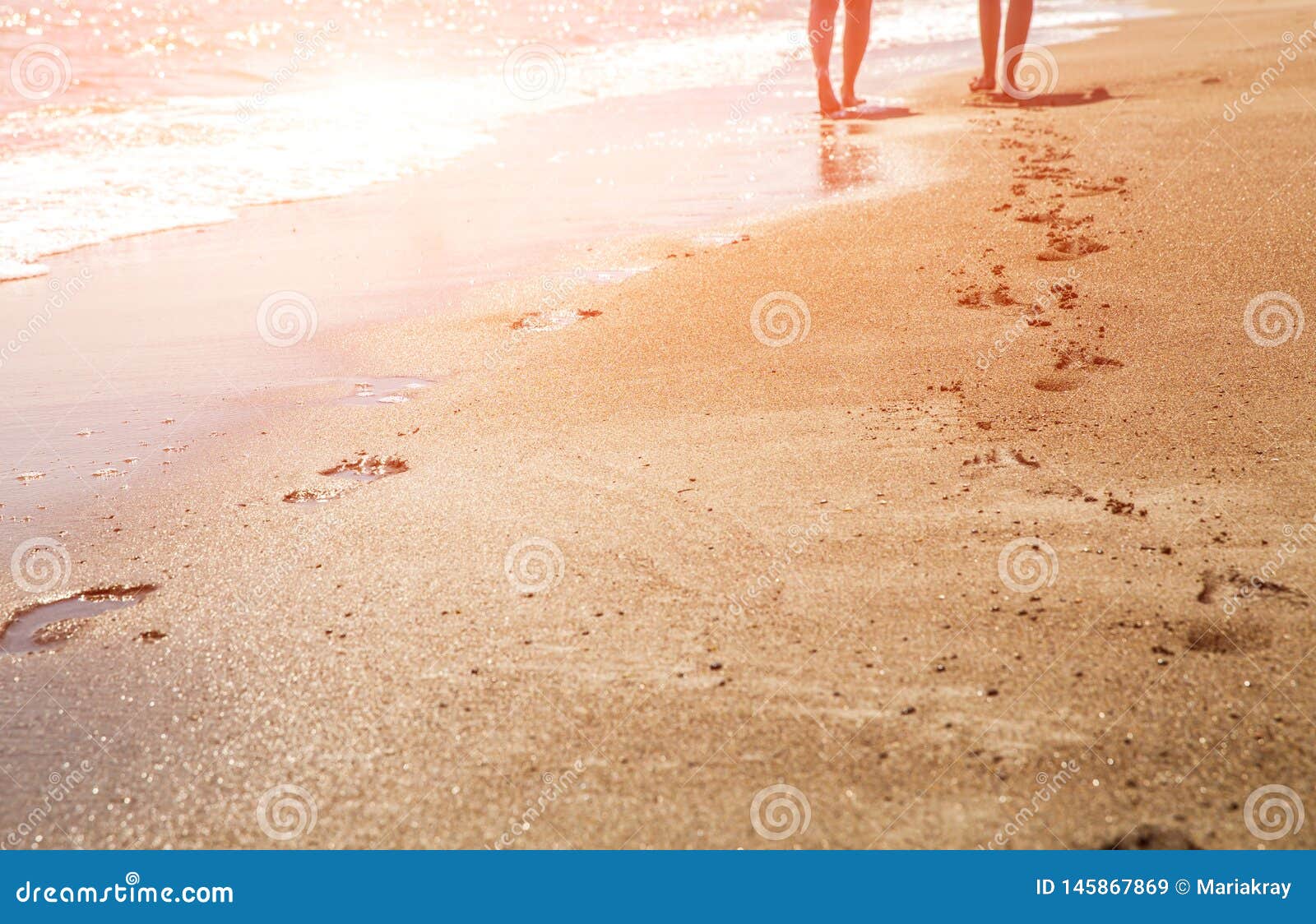 Beach, Wave and Women Footprints at Sunset Time with Sun Flare Stock ...