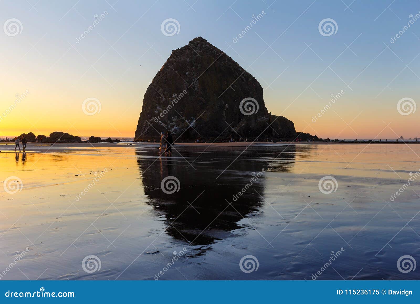 Cannon Beach, Oregon Coast: The Famous Haystack Rock Reflects Itself In ...
