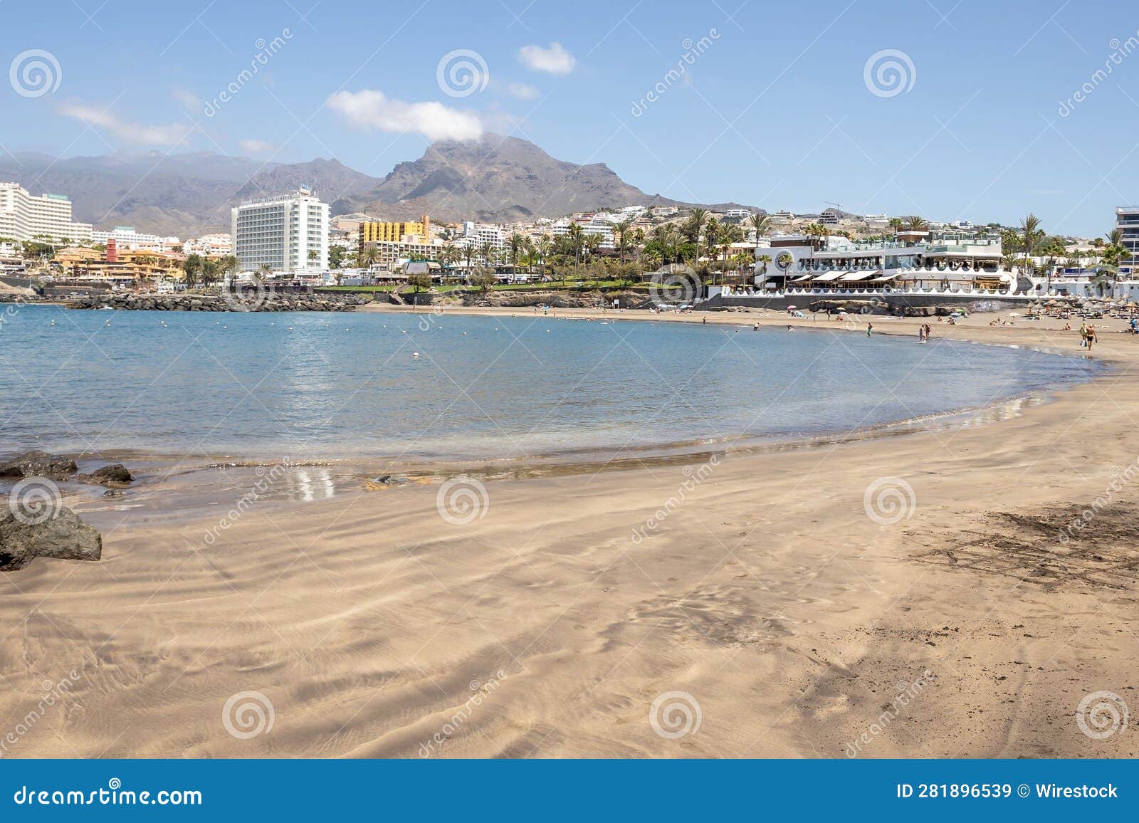 Beachfront Town with a Rocky Cliffside, Featuring Multiple Buildings ...