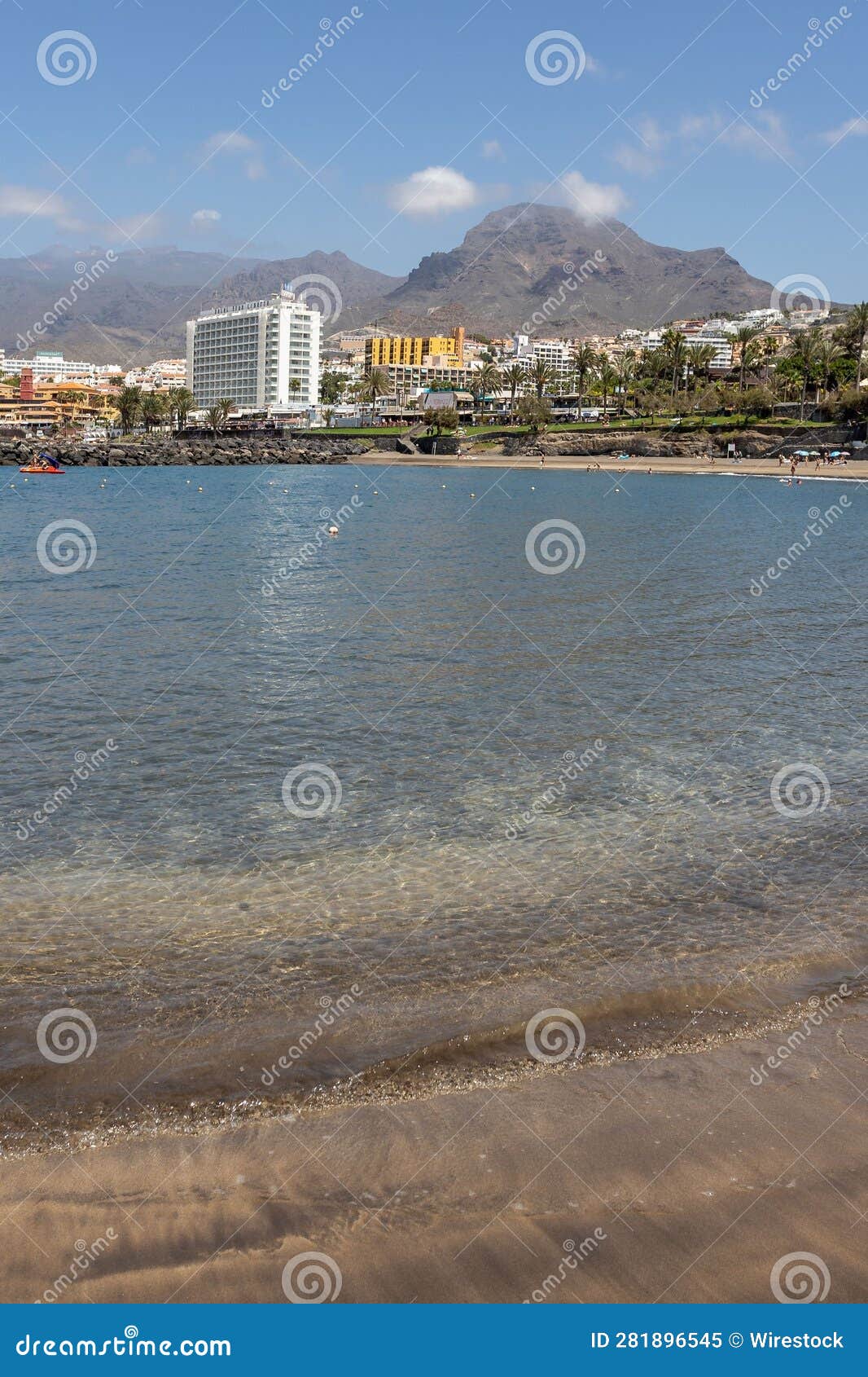 Beachfront Town with a Rocky Cliffside, Featuring Multiple Buildings ...