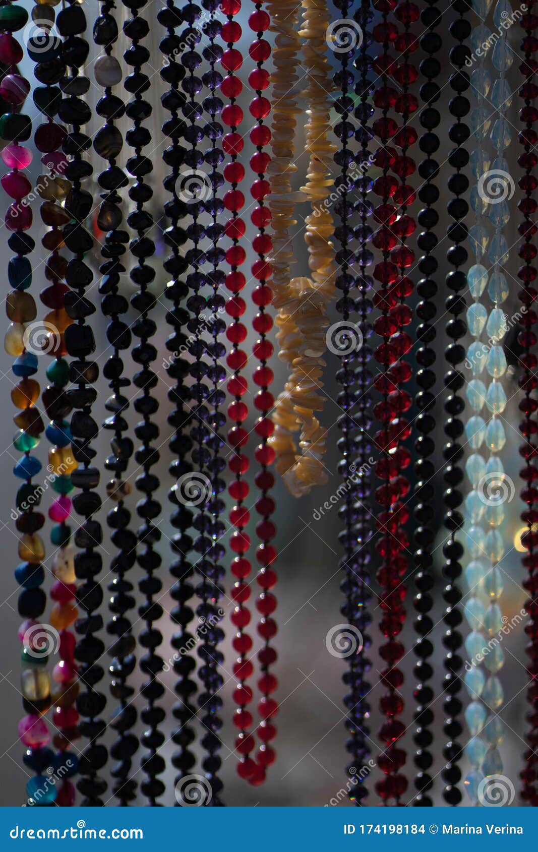 Beads Hang from Multi-colored Pebbles Stock Photo - Image of closeup ...