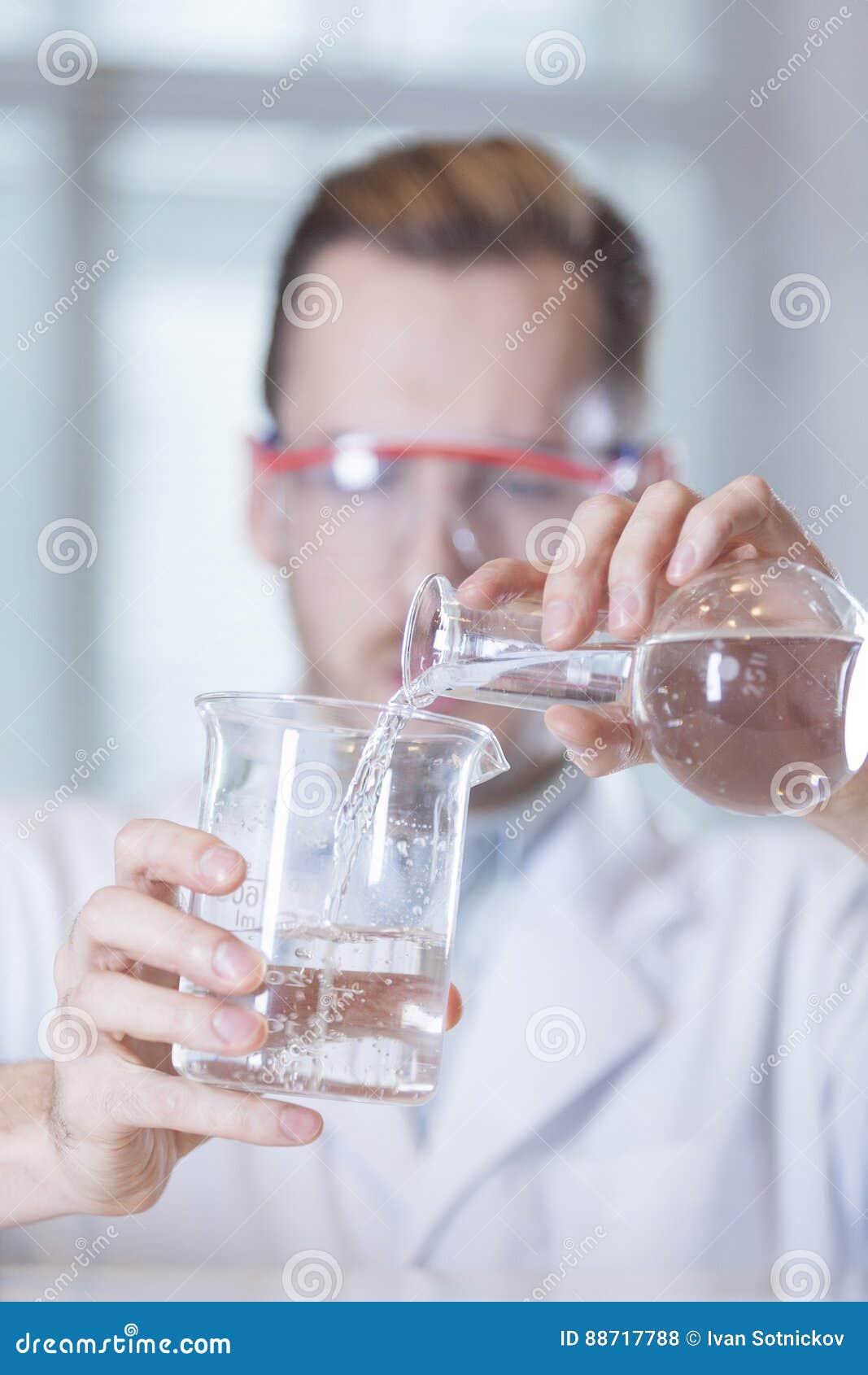 Beaker and Flask with Liquids in the Hands of the Scientist Stock Photo ...