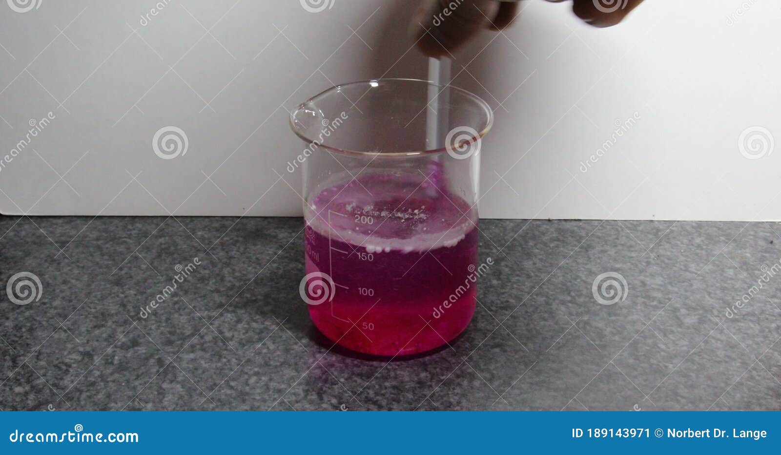 Beaker with Liquid is Coloured Dark Purple by Adding a Powder Stock ...