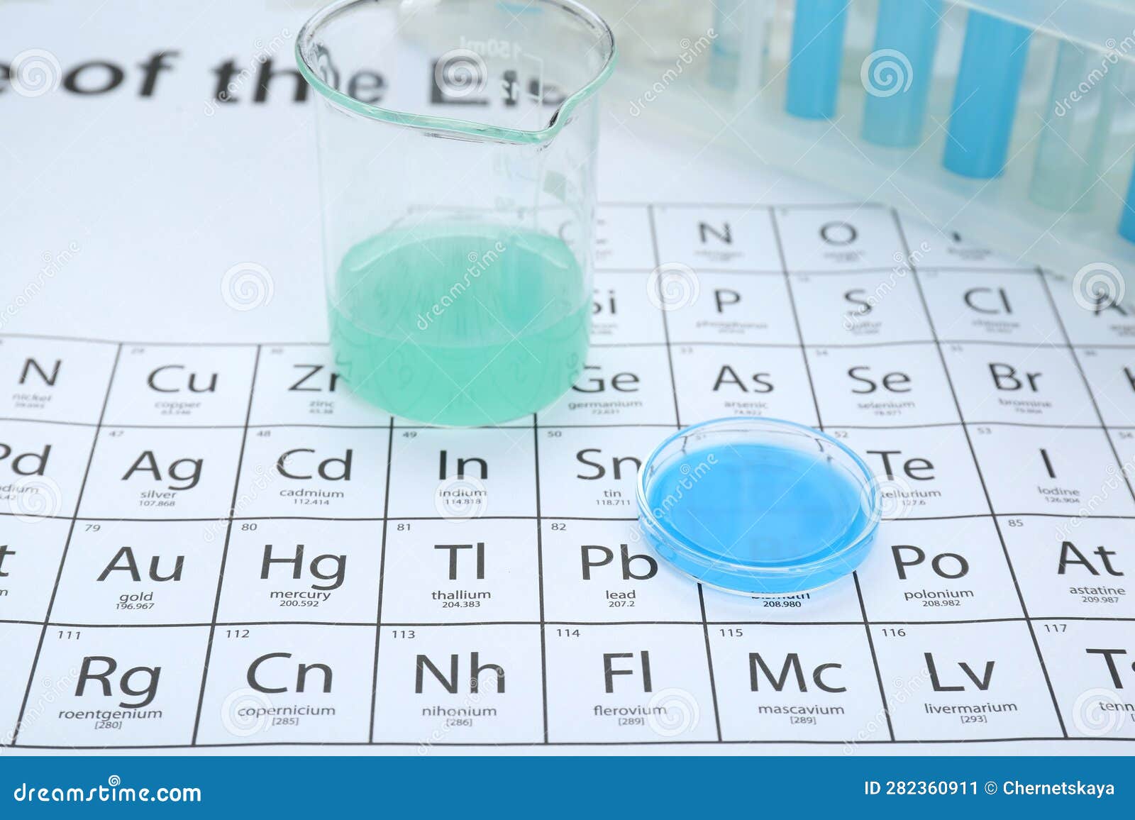 Beaker and Petri Dish on Periodic Table of Chemical Elements, Closeup ...
