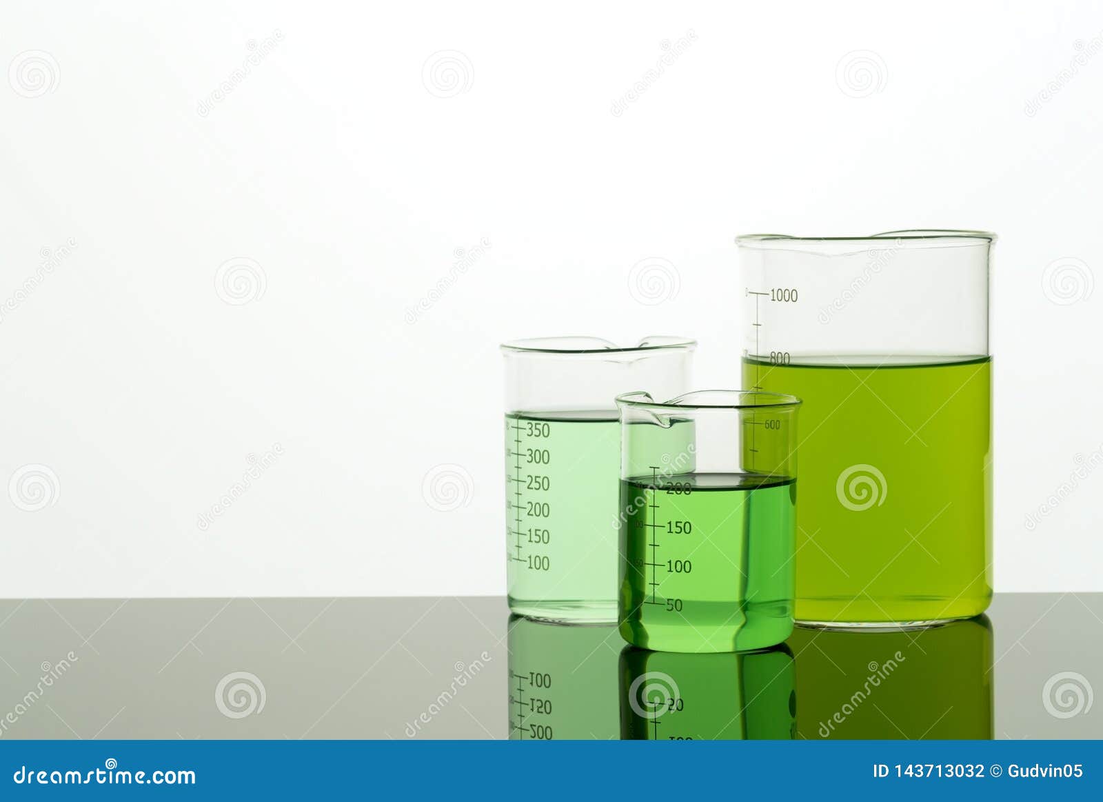 Beakers of Different Size with Green Liquid. Copy Space. Stock Photo ...