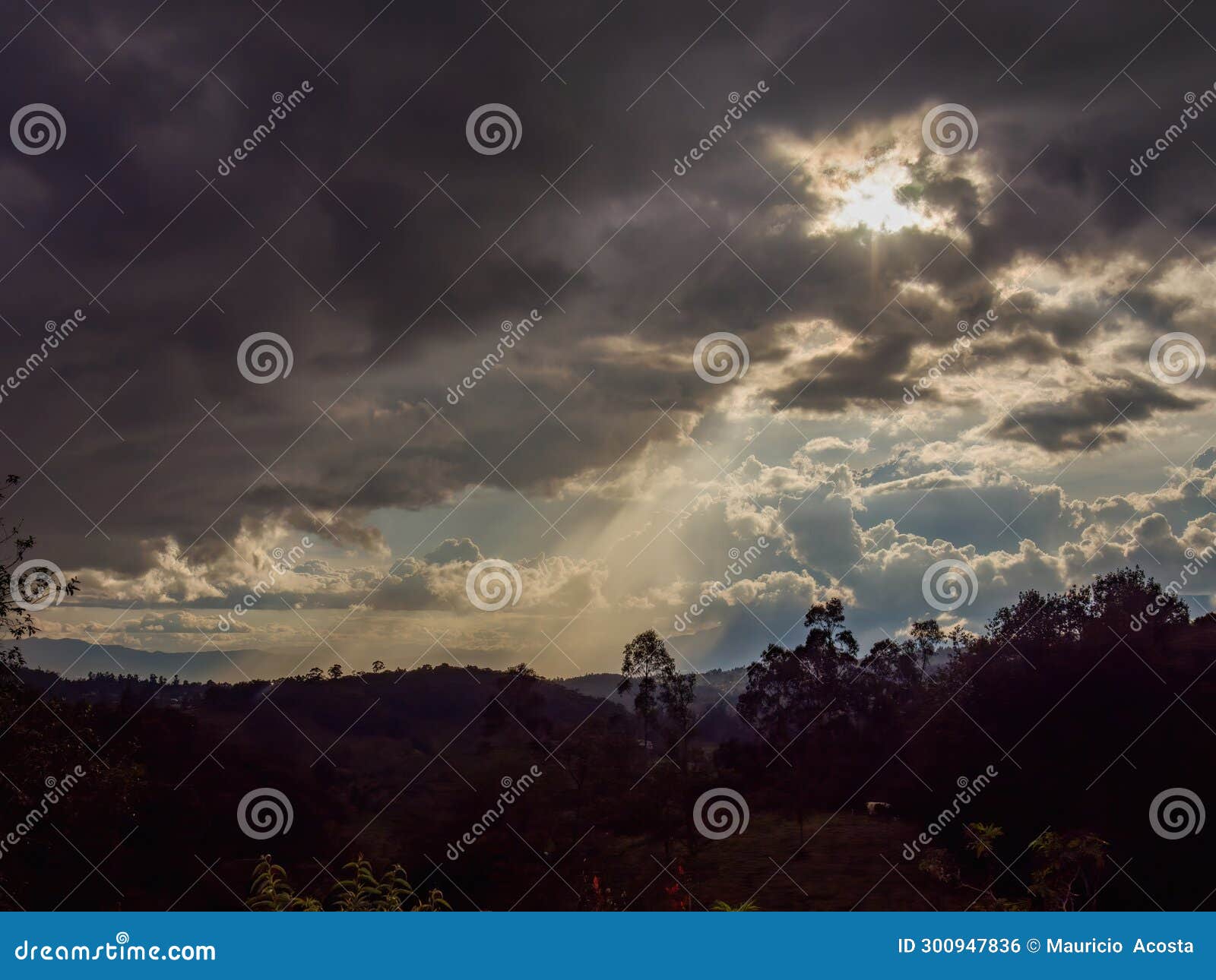 A Beam of Sun Light Emerges from Dense Clouds in the Sky Stock Photo ...
