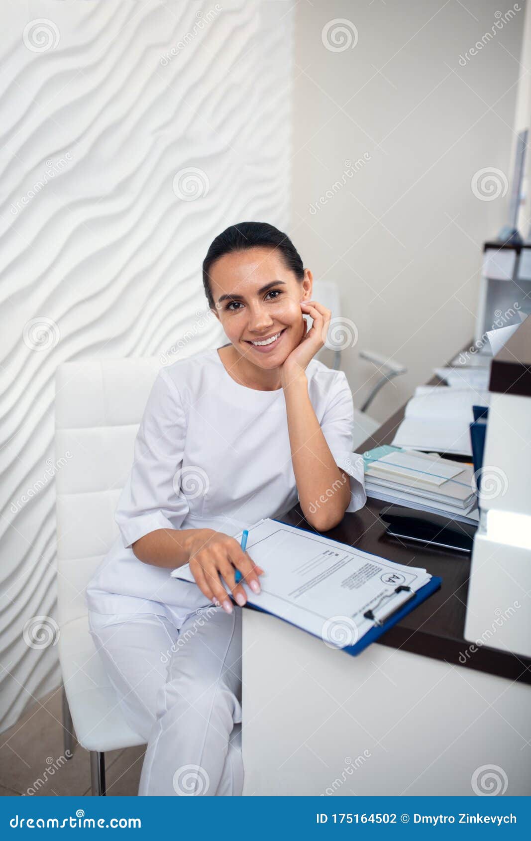 Beaming Receptionist Smiling while Starting Working Day Stock Photo ...