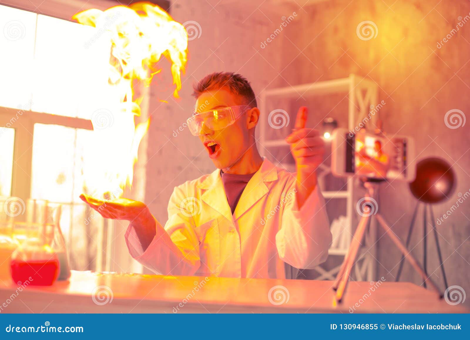 Beaming Young Man Excitingly Looking on Fire on His Hand Stock Image ...