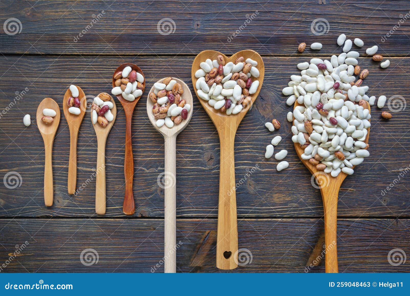 Beans in Wooden Spoons on Rustic Table, Concept of Growth Stock Image ...