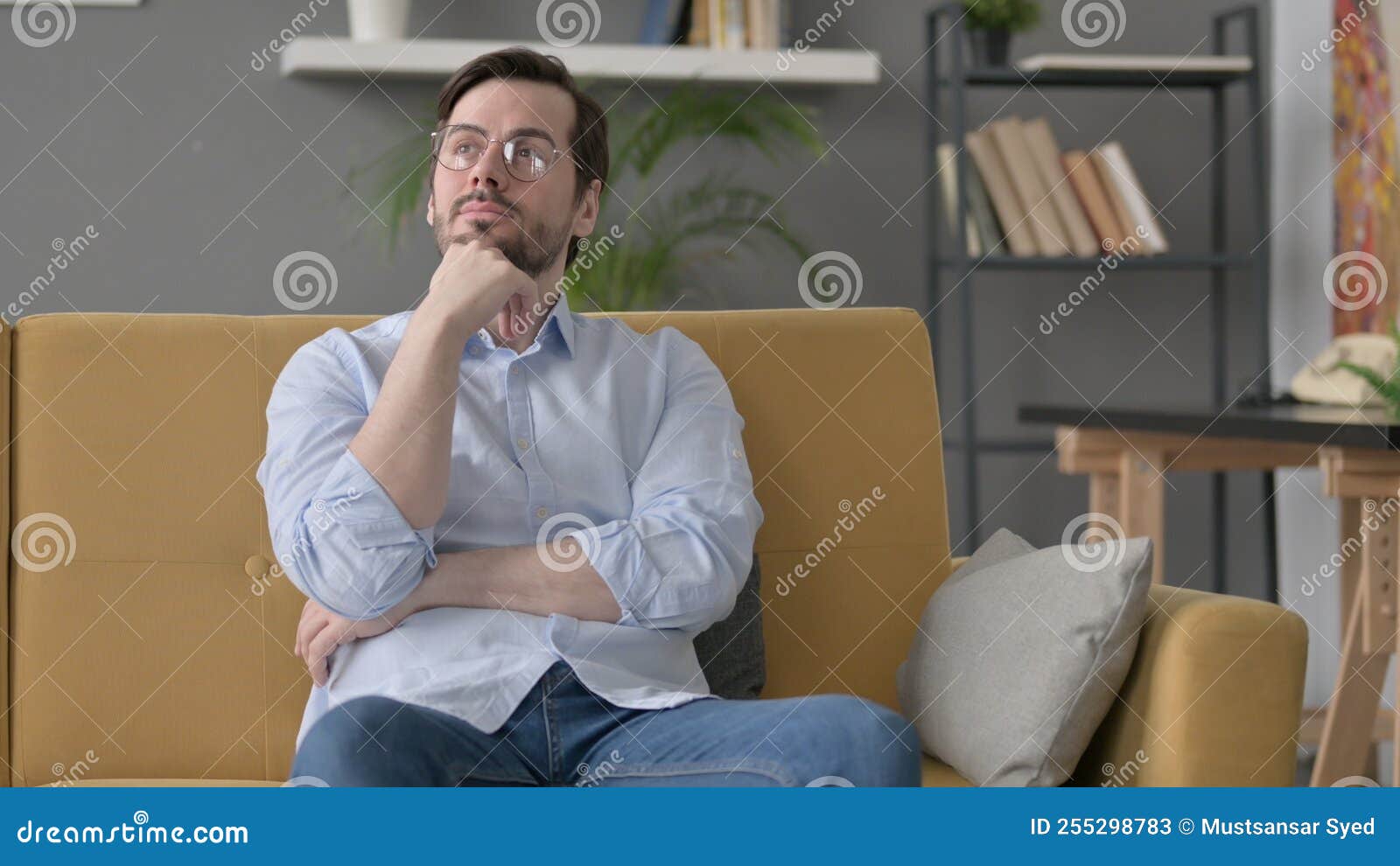Young Man Thinking while Sitting on Sofa Stock Image - Image of sofa ...
