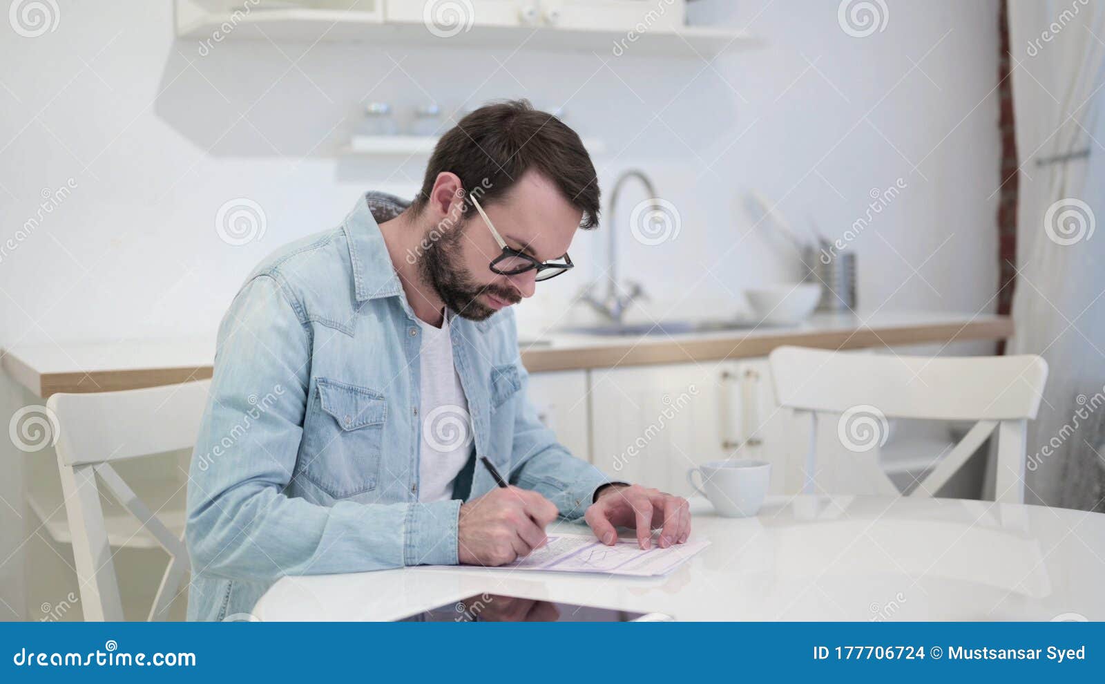 Beard Young Man Thinking and Writing on Paper Stock Photo - Image of ...