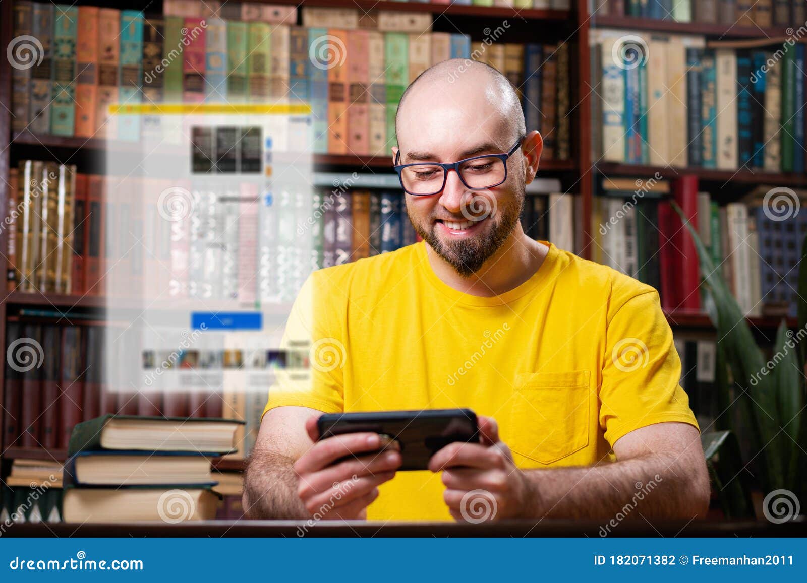 A Bearded Bald Man With Glasses And A Smile Uses A Smartphone Digital