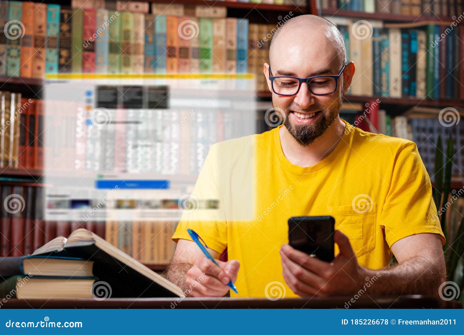 A Bearded Bald Man With Glasses And A Smile Uses A Smartphone And