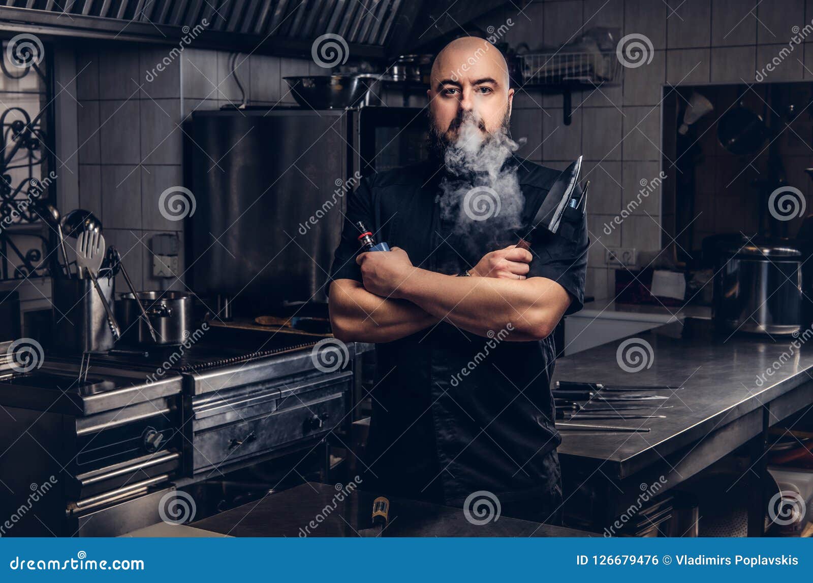 Bearded Chef in Black Uniform Smoking E-cigarette while Standing in the ...