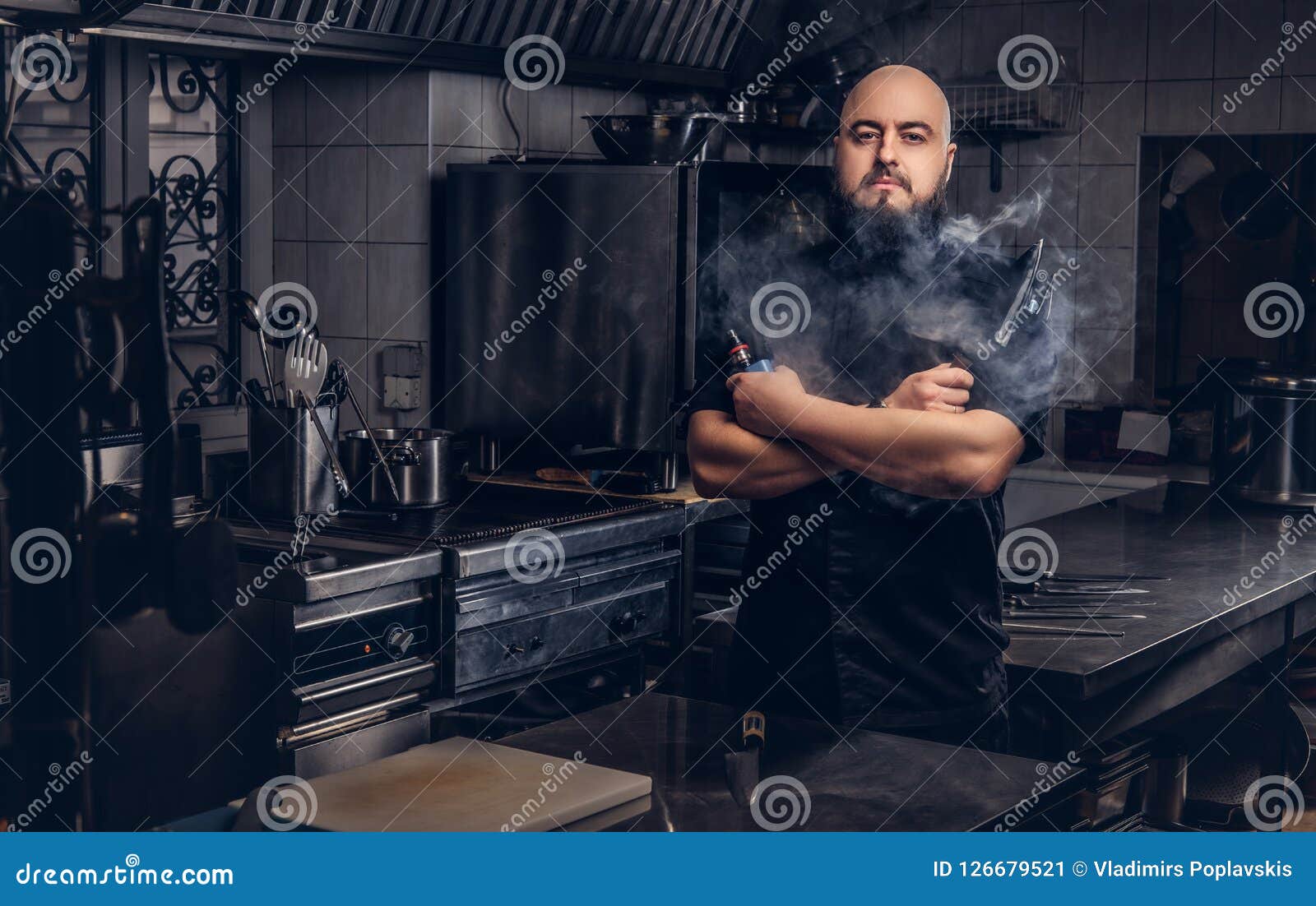 Bearded Chef in Black Uniform Smoking E-cigarette while Standing in the ...