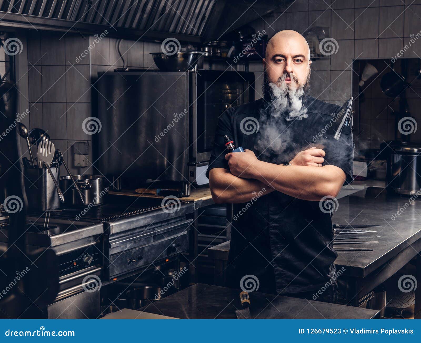 Bearded Chef in Black Uniform Smoking E-cigarette while Standing in the ...