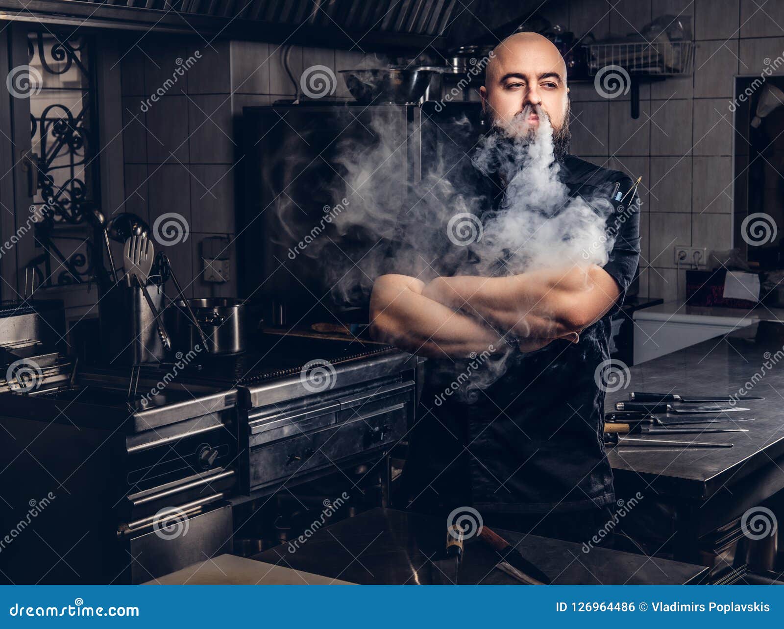 Bearded Chef in Black Uniform Smoking E-cigarette while Standing in the ...