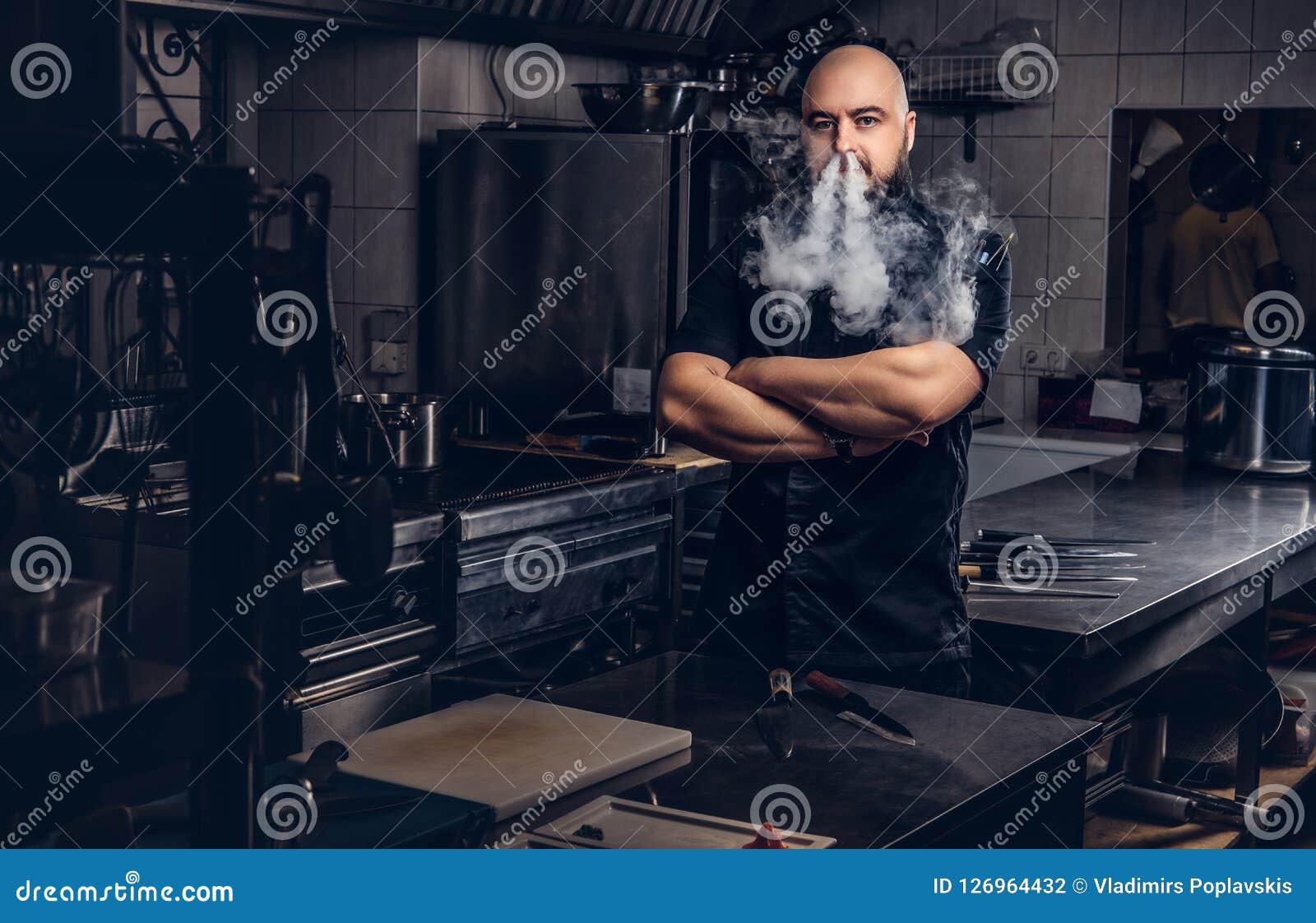 Bearded Chef in Black Uniform Smoking E-cigarette while Standing in the ...