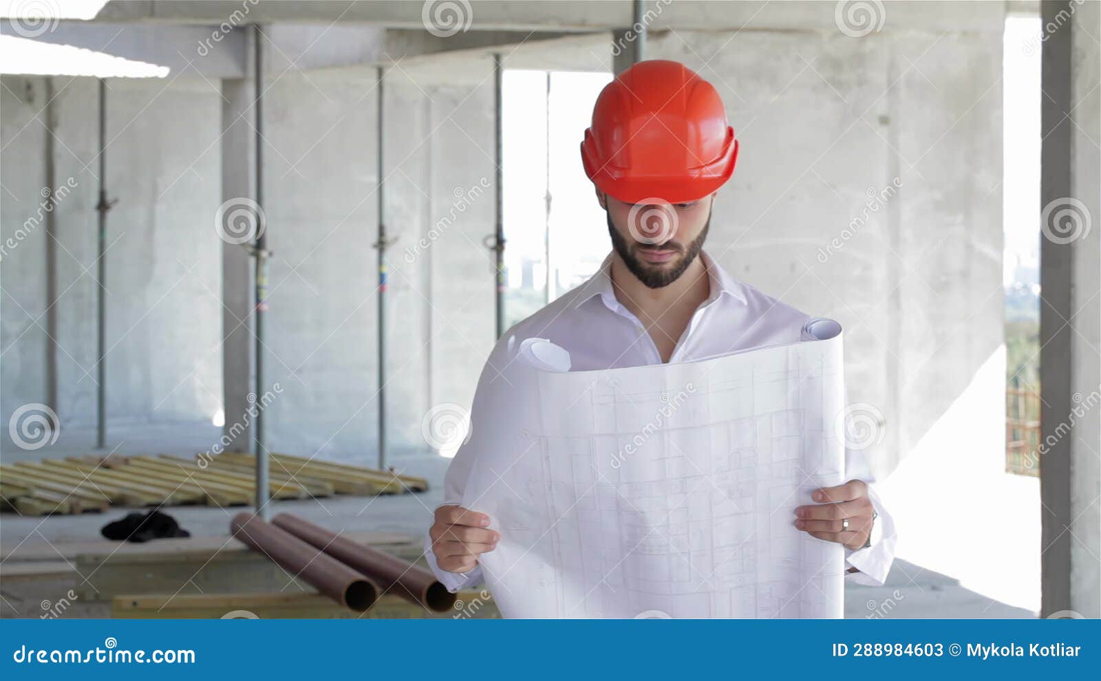 Construction Engineer Walks through the Building Under Construction ...