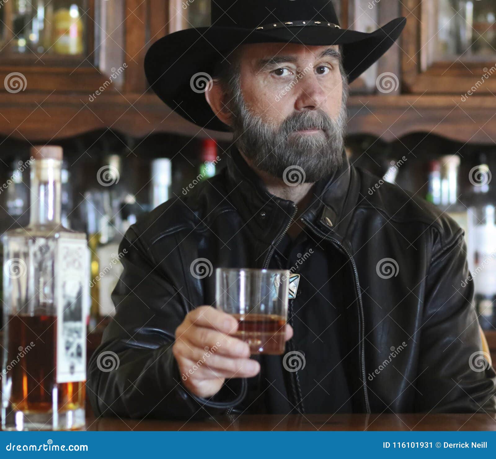 A Bearded Cowboy in Black Sitting Alone in a Saloon Stock Image - Image ...