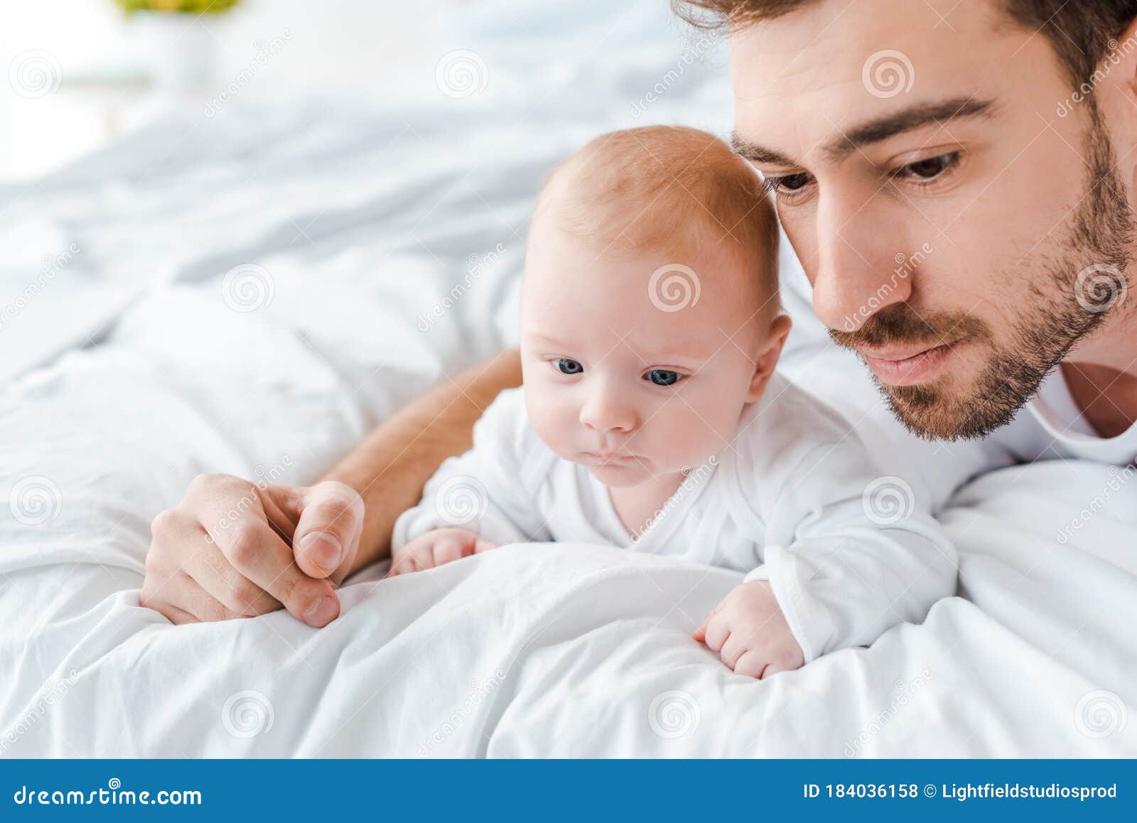 Bearded Dad with Cute Baby on Bed Stock Photo - Image of adorable ...