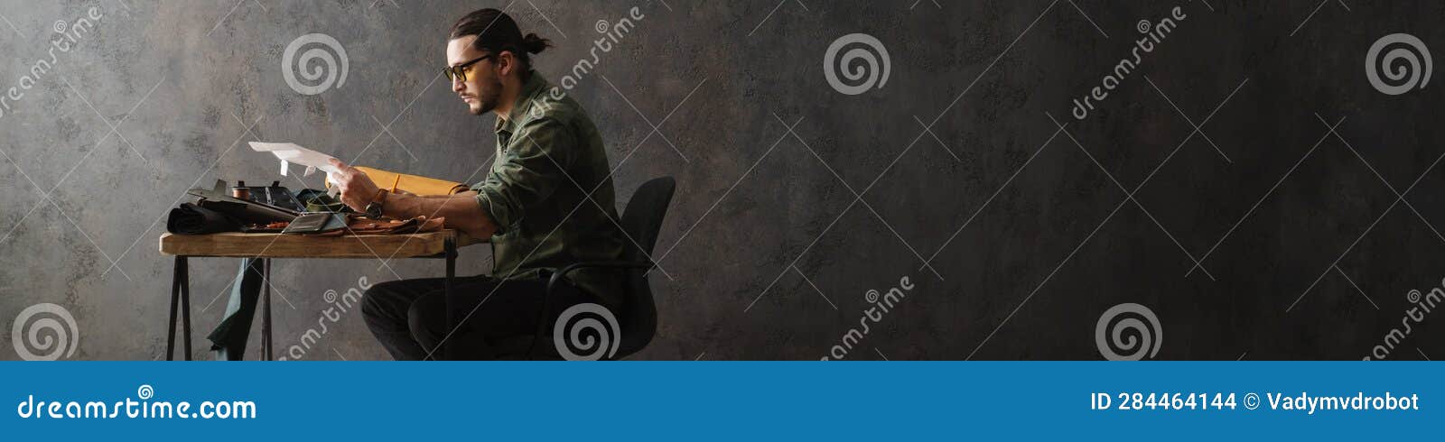 Bearded Focused Craftsman Writing Down Notes while Working with Leather ...