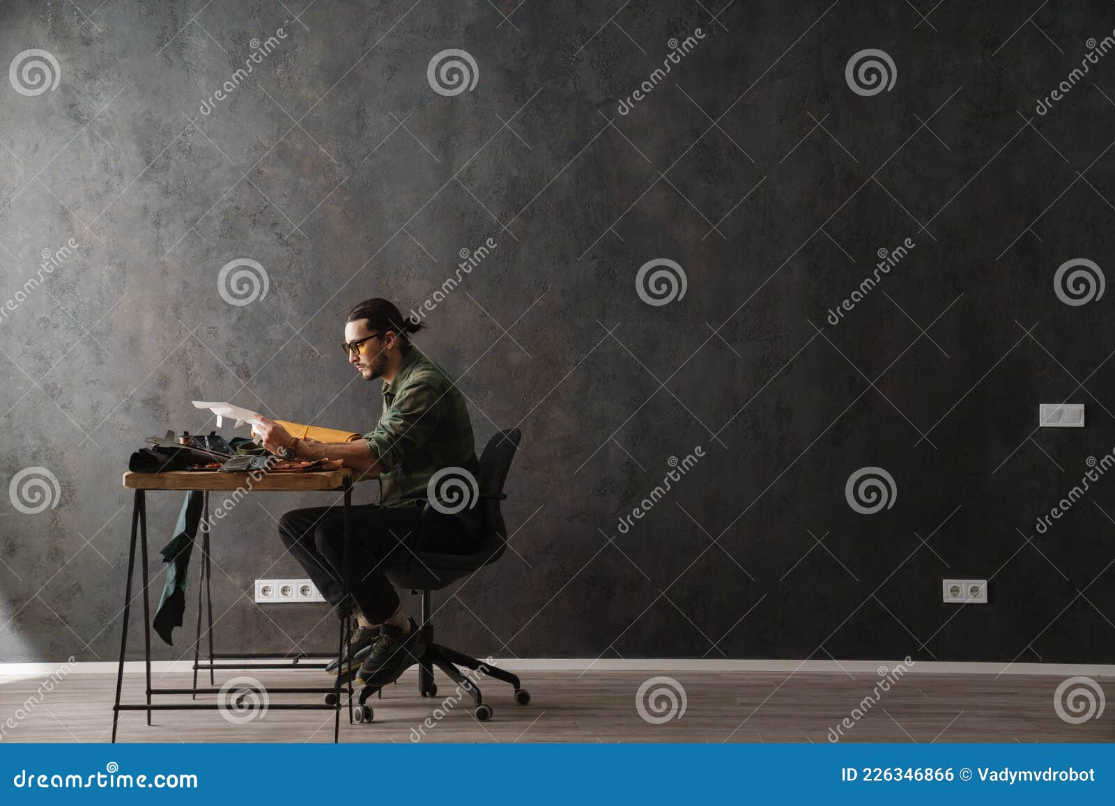 Bearded Focused Craftsman Writing Down Notes while Working with Leather ...