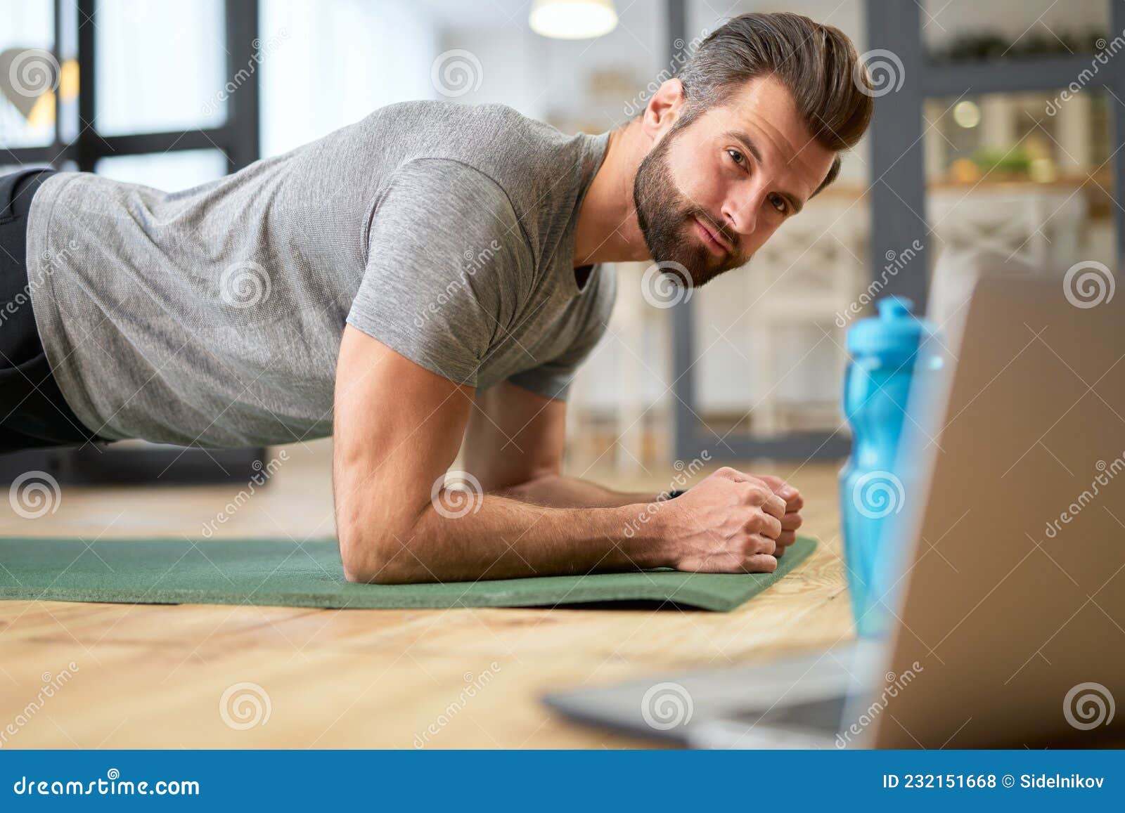 Handsome Young Man Using Notebook and Doing Plank at Home Stock Photo ...