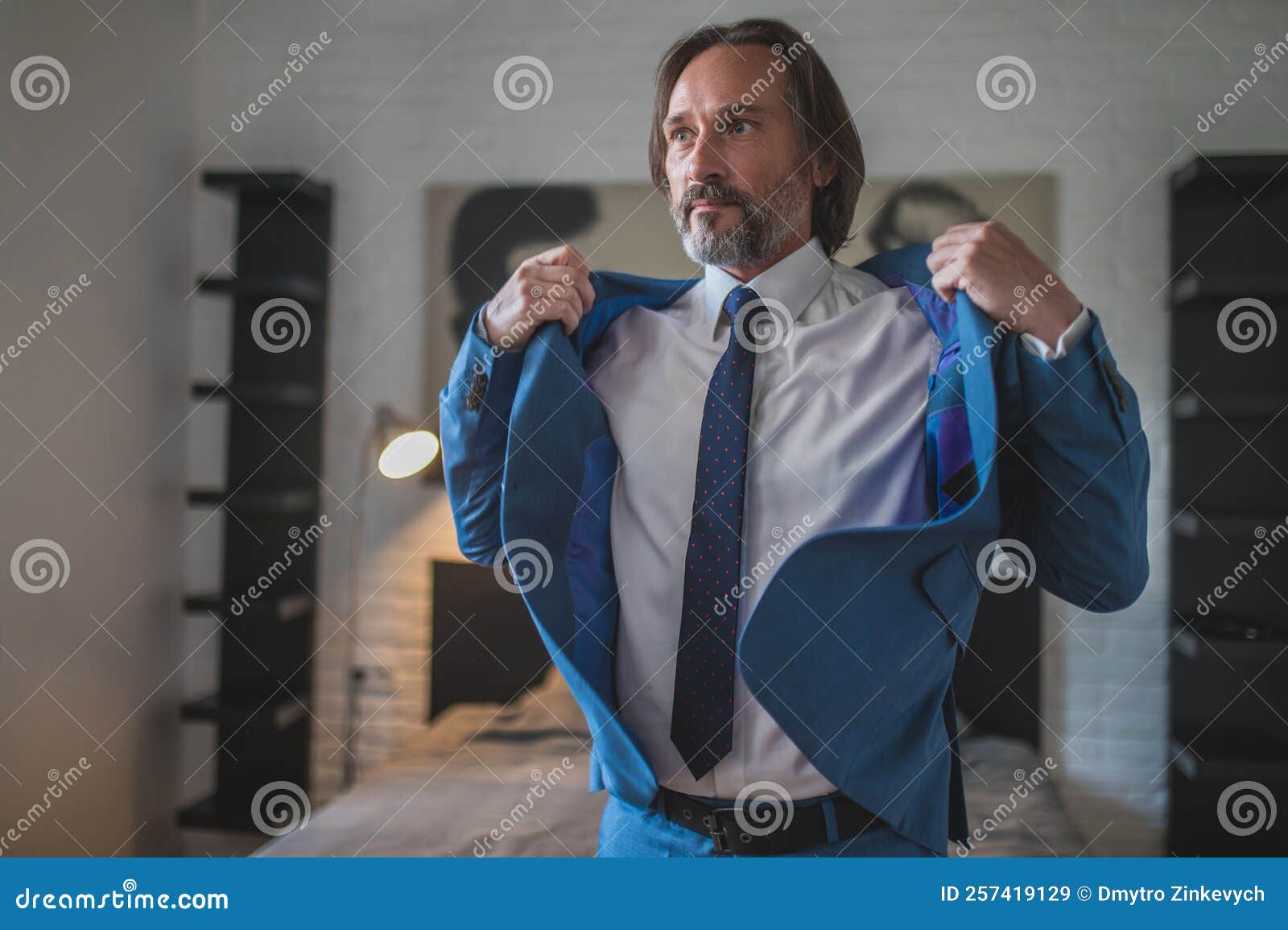 Bearded Good-looking Man Putting On His Jacket Stock Photo ...