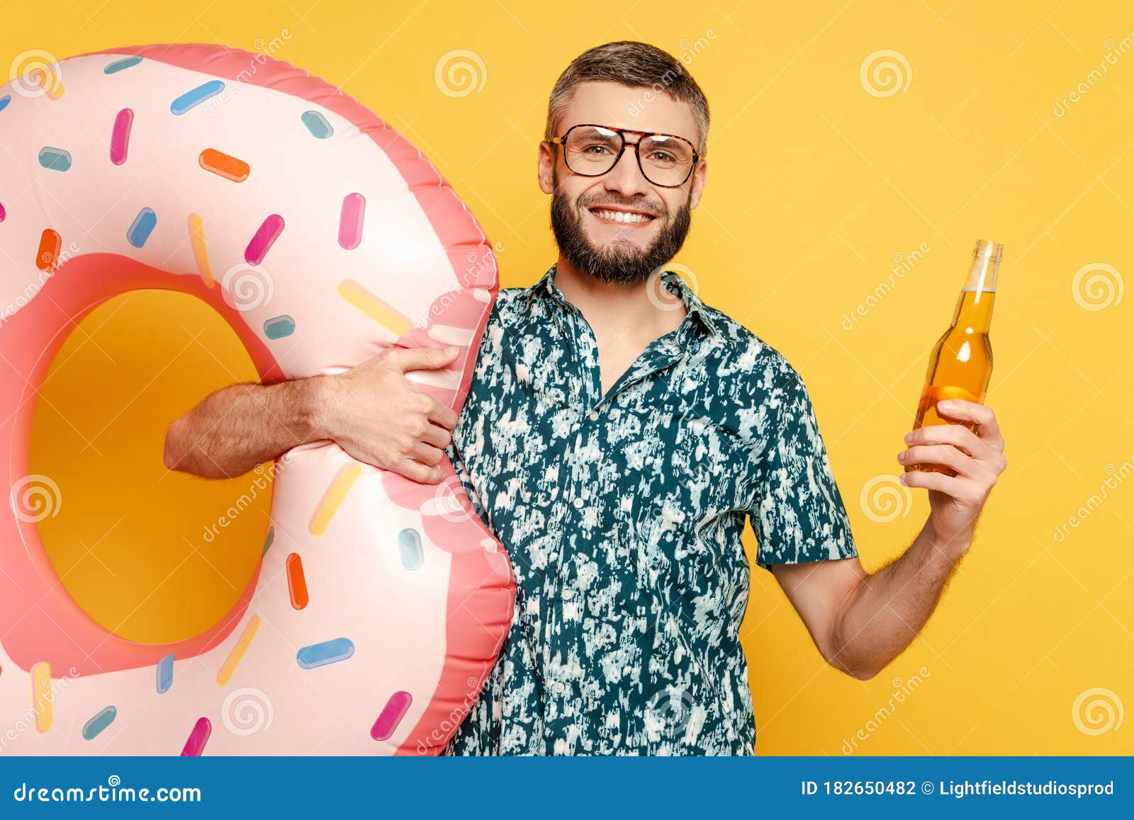 Bearded Guy In Glasses With Donut Swim Ring And Beer On Yellow Stock