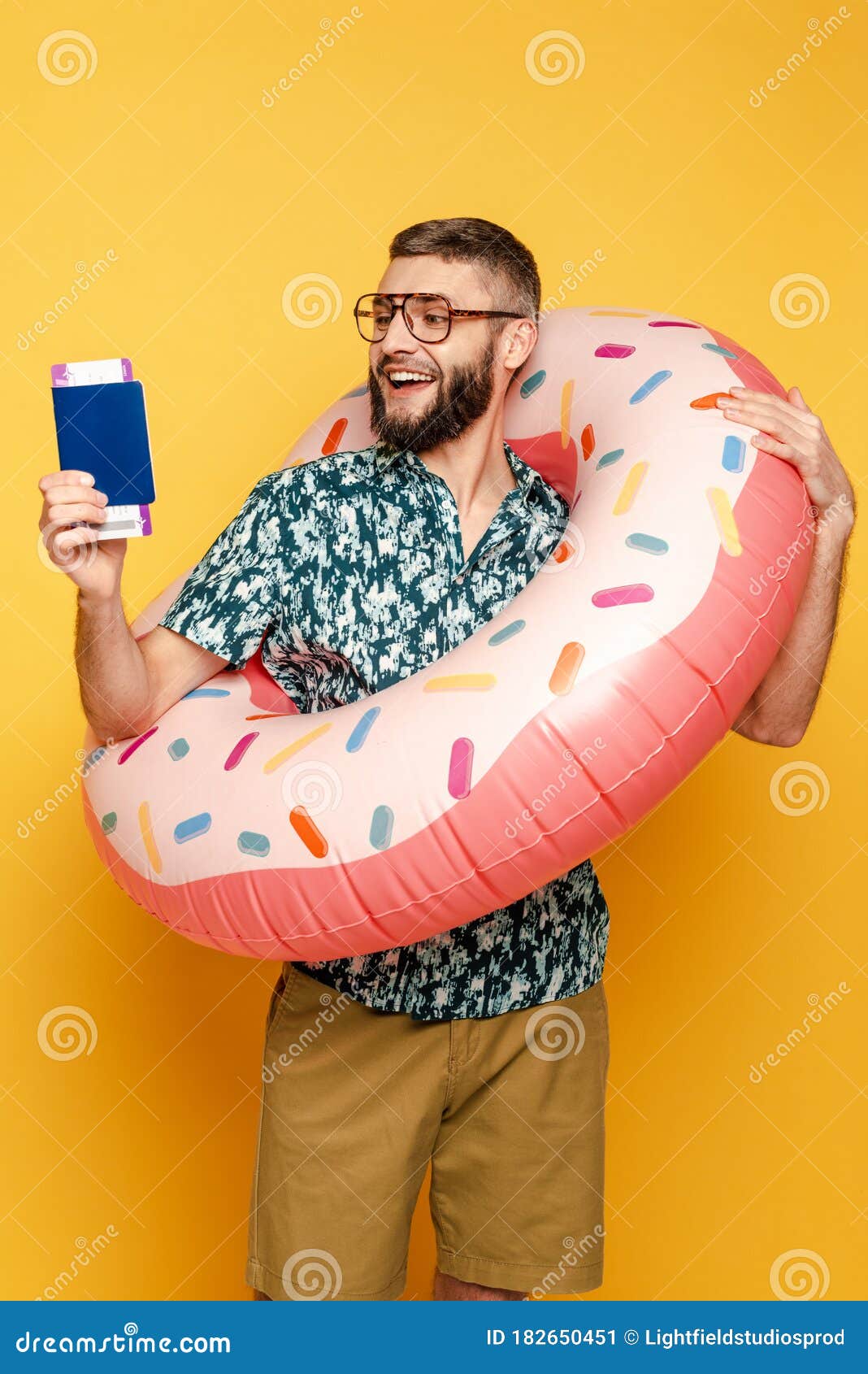 Bearded Guy In Glasses With Donut Swim Ring And Passport On Yellow
