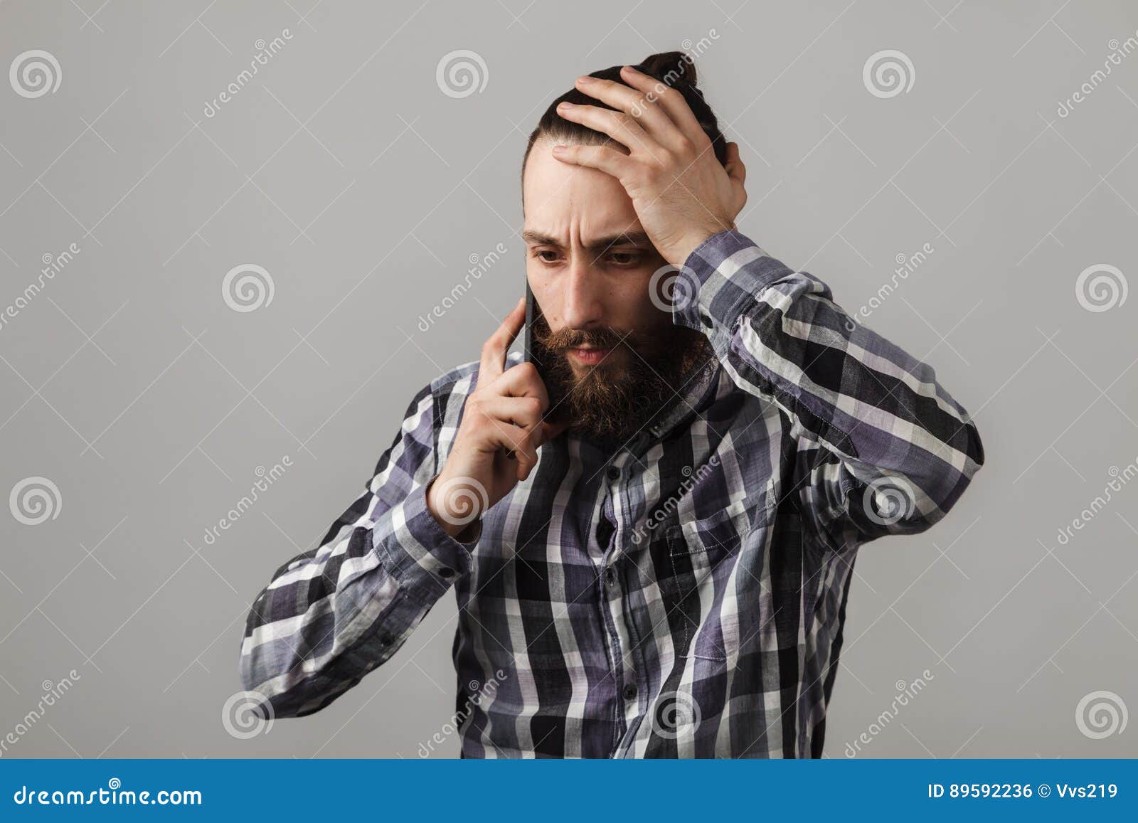 Bearded Handsome Sad Man is Talking by Phone in Blue Squared Shirt on ...