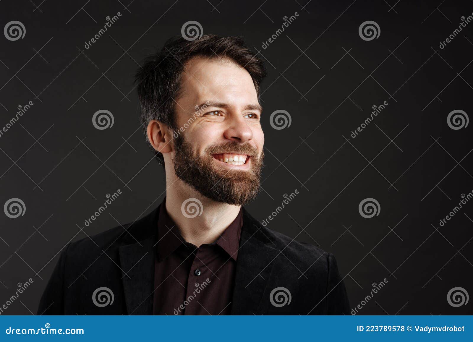 Bearded Happy Man in Black Jacket Smiling and Looking Aside Stock Photo ...