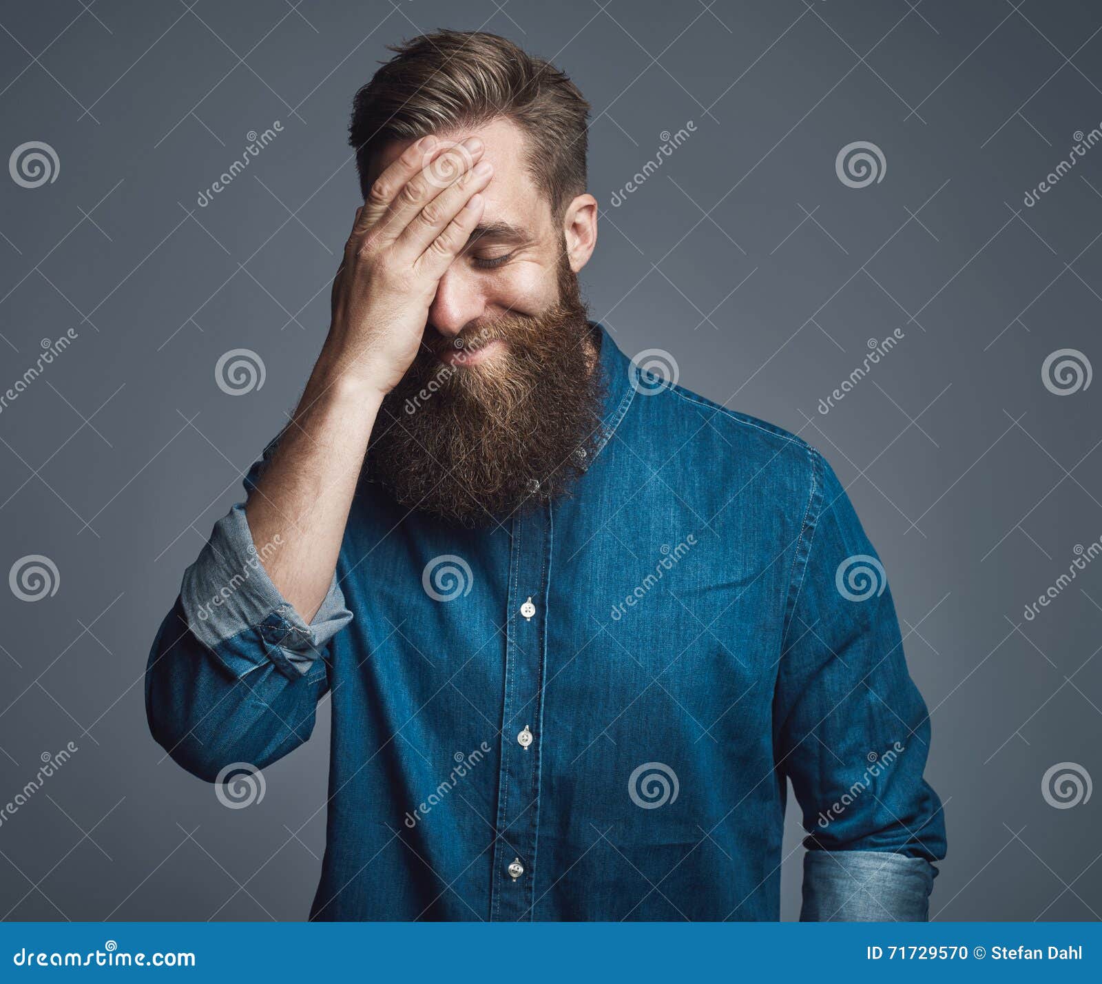 Bearded Man in Blue Denim Shirt with Hand on Head Stock Photo - Image ...